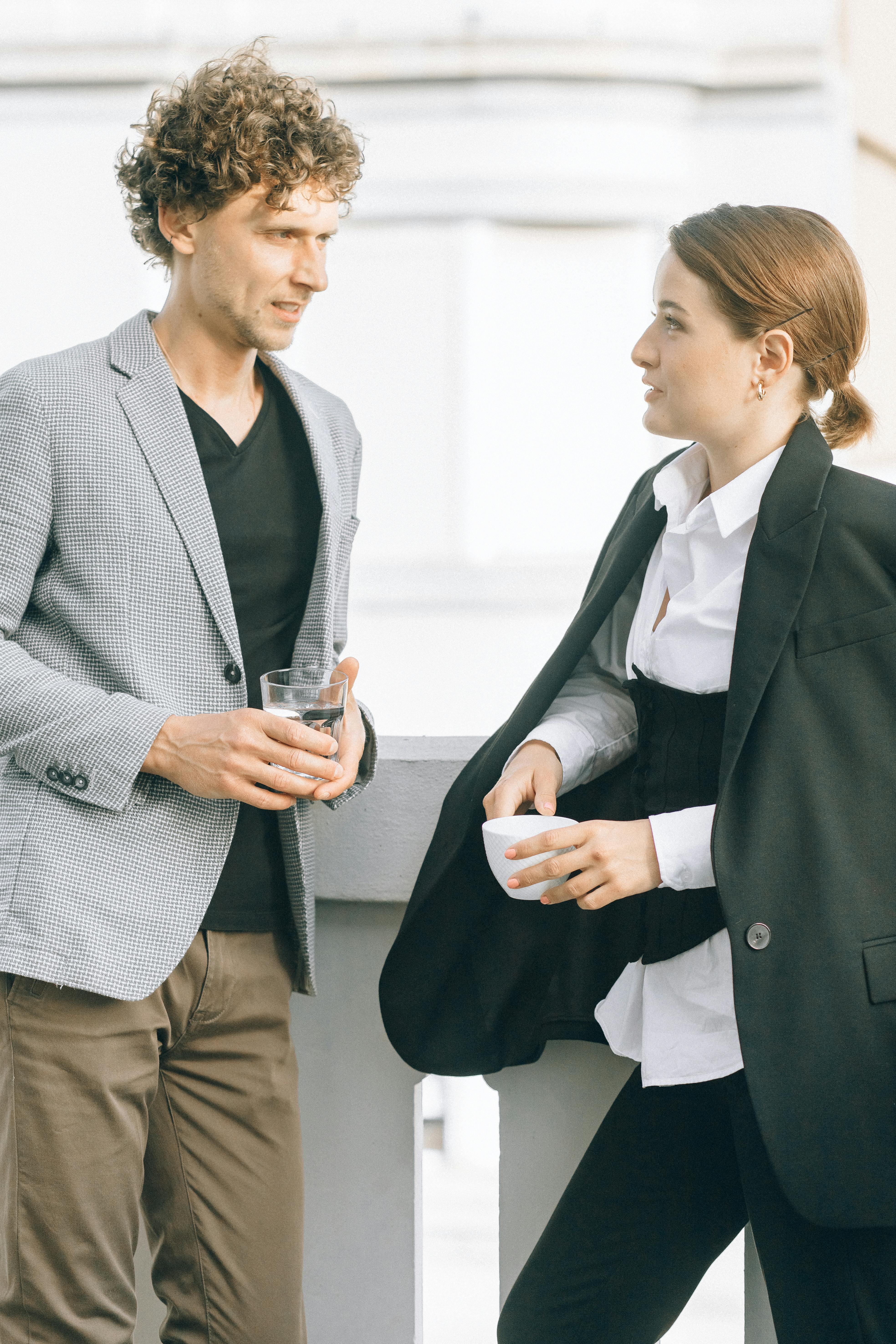 Man and Woman Talking while Standing · Free Stock Photo