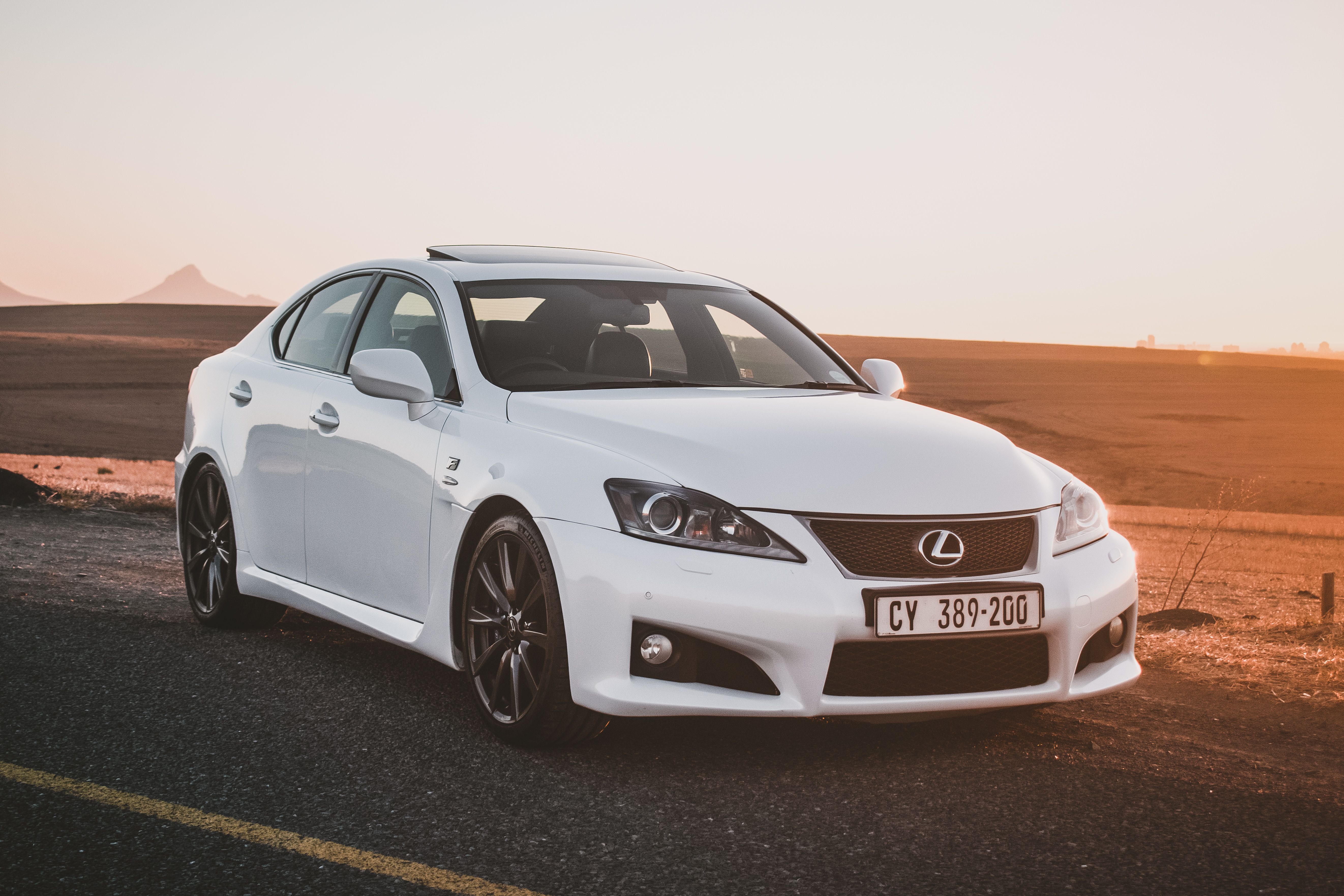 White Lexus Car Parked on the Side of an Asphalt Road · Free Stock Photo