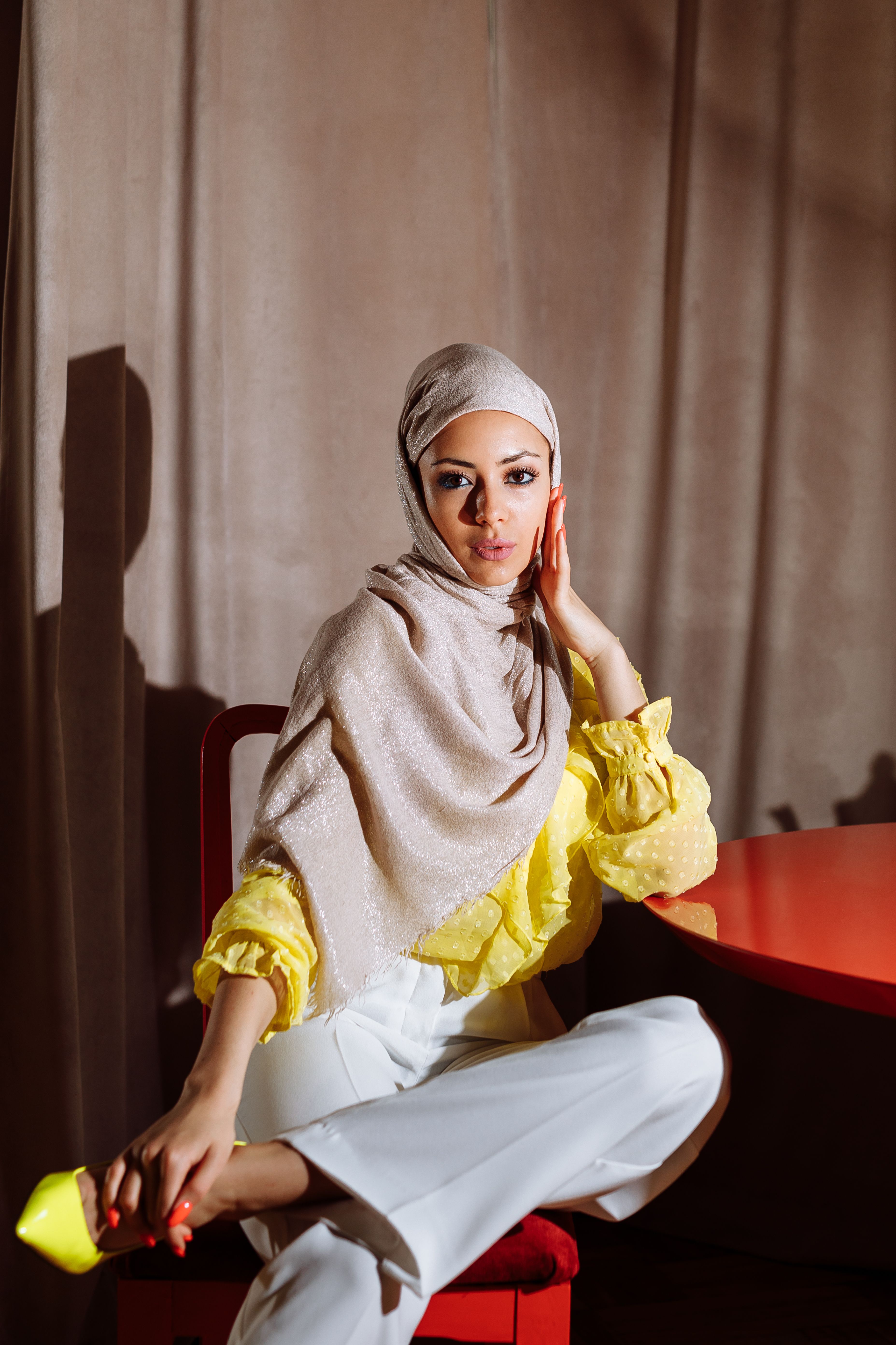 Beautiful Woman in Beige Hijab Sitting on a Chair · Free Stock Photo