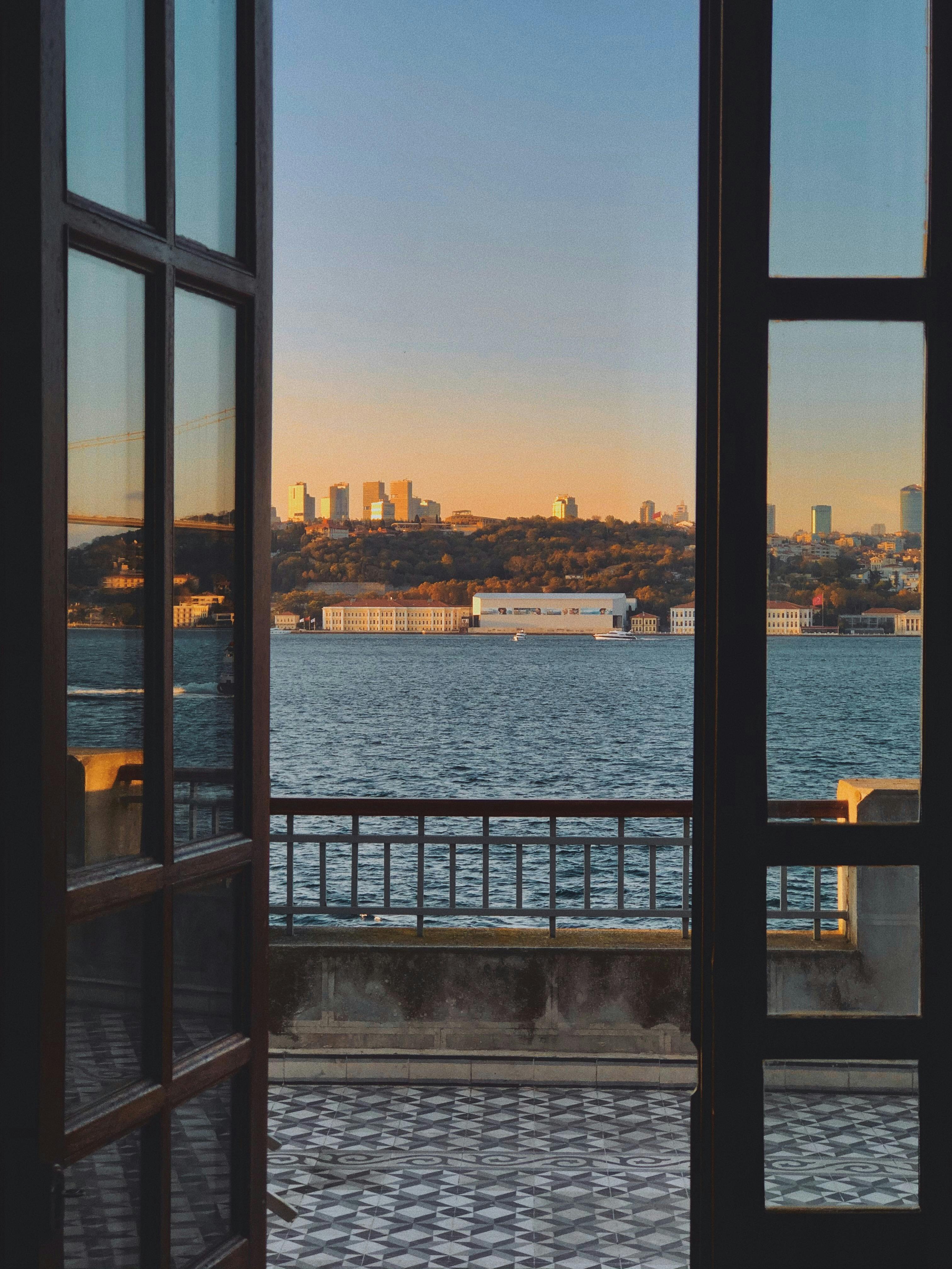 Cityscape Visible From Behind Open Balcony Door at a Waterfront House ...