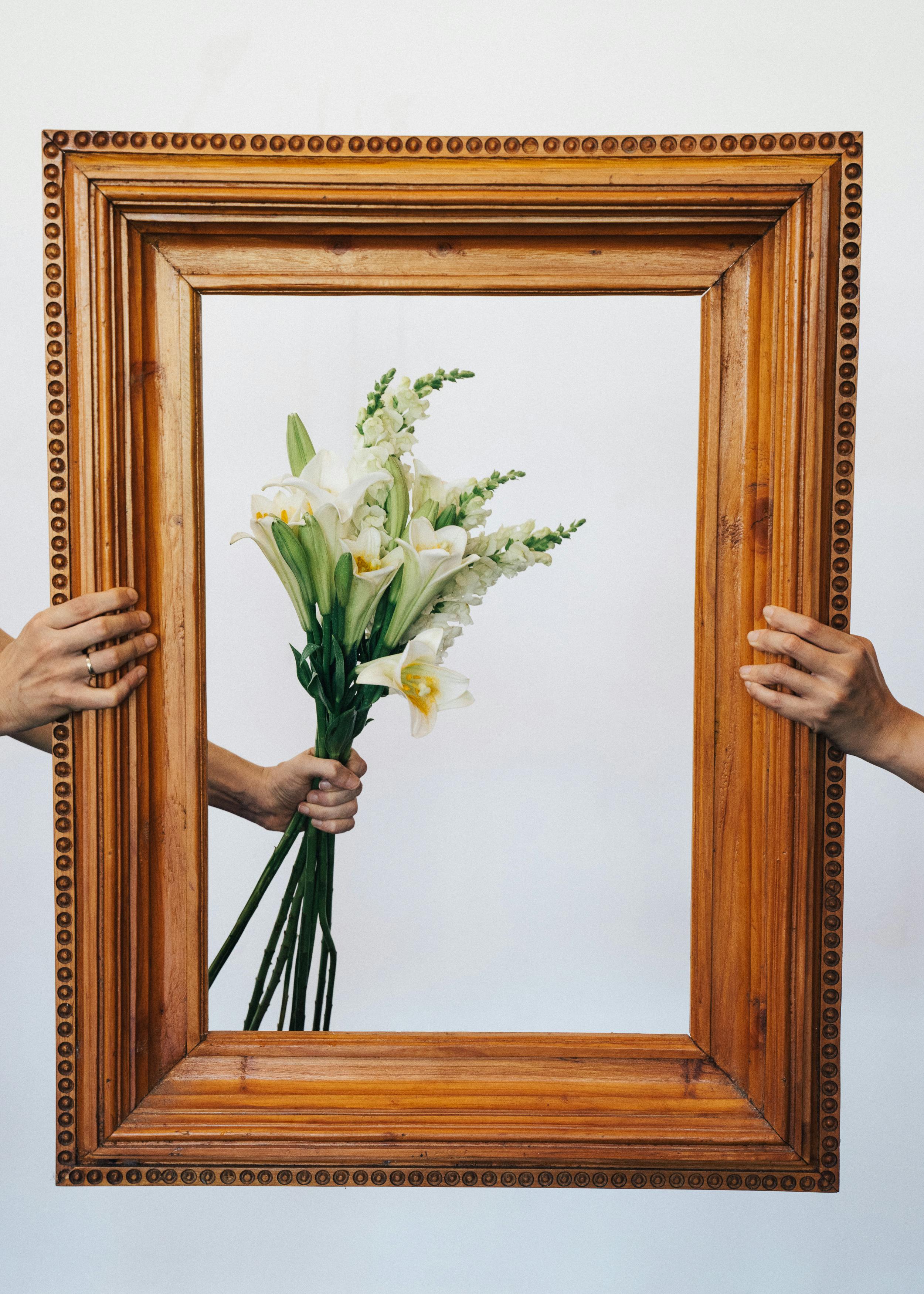 Person Holding Brown Wooden Frame · Free Stock Photo