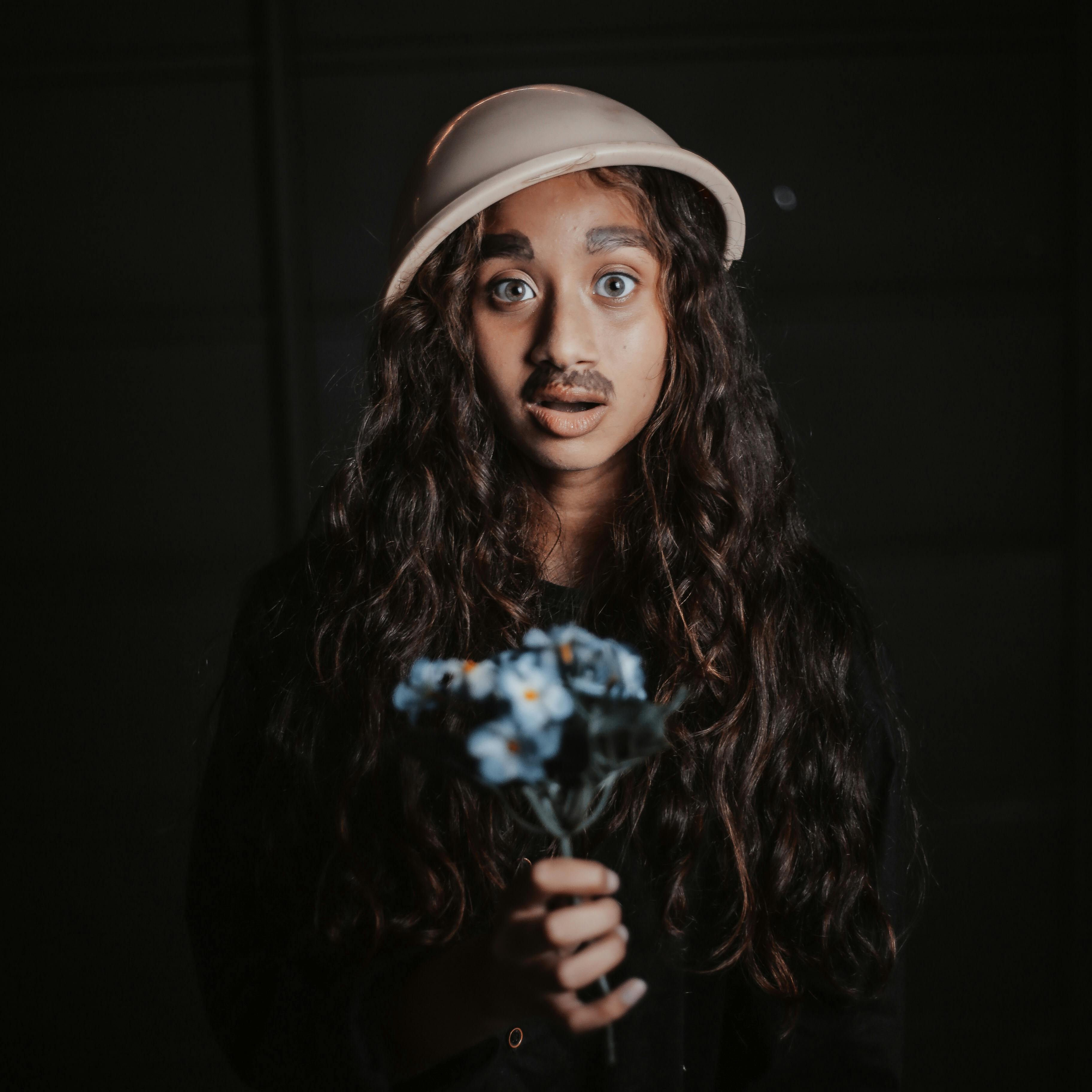Woman with Drawn Moustache and a Pot on Her Head Making a Face and ...