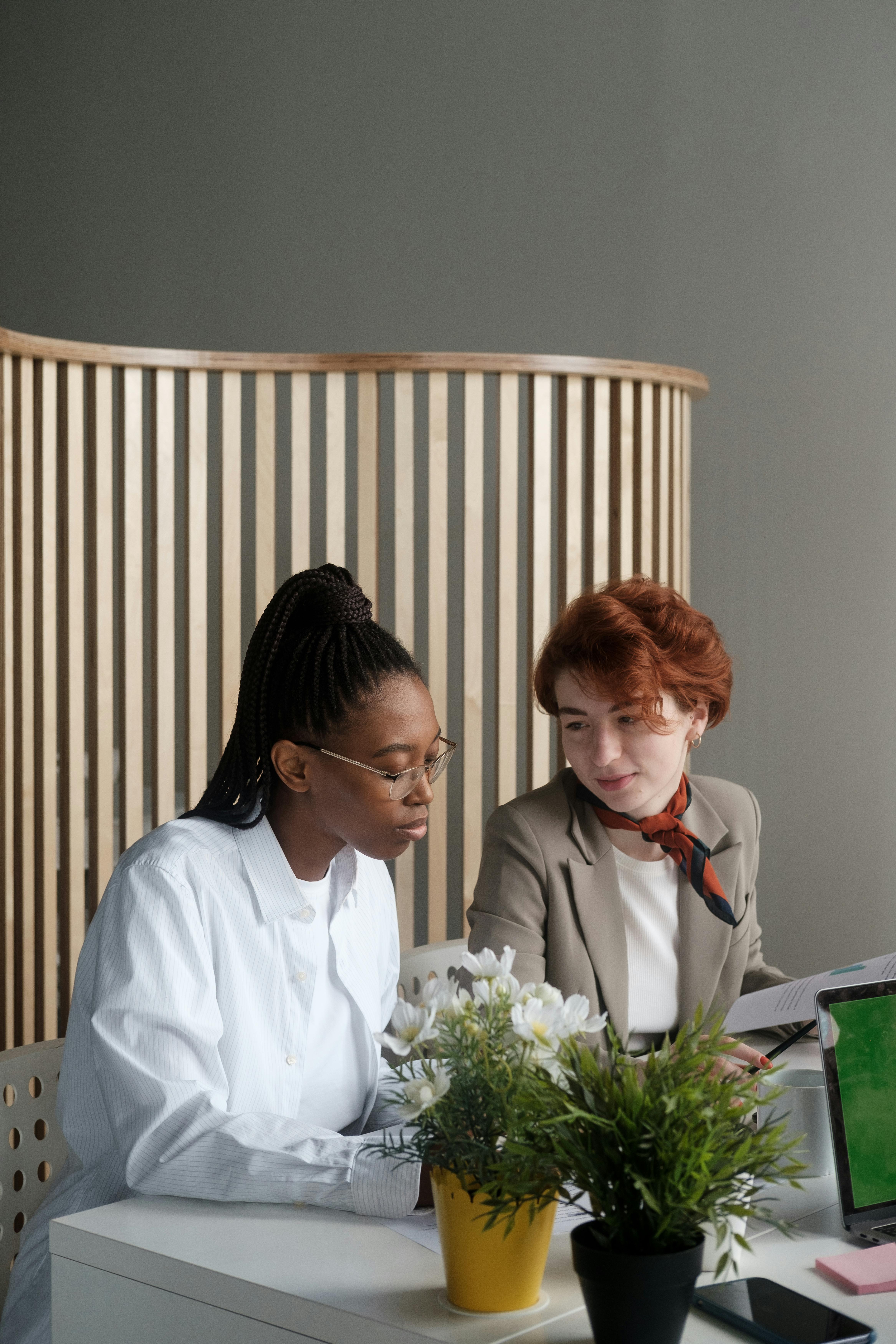 Women Sitting by Table at Work · Free Stock Photo