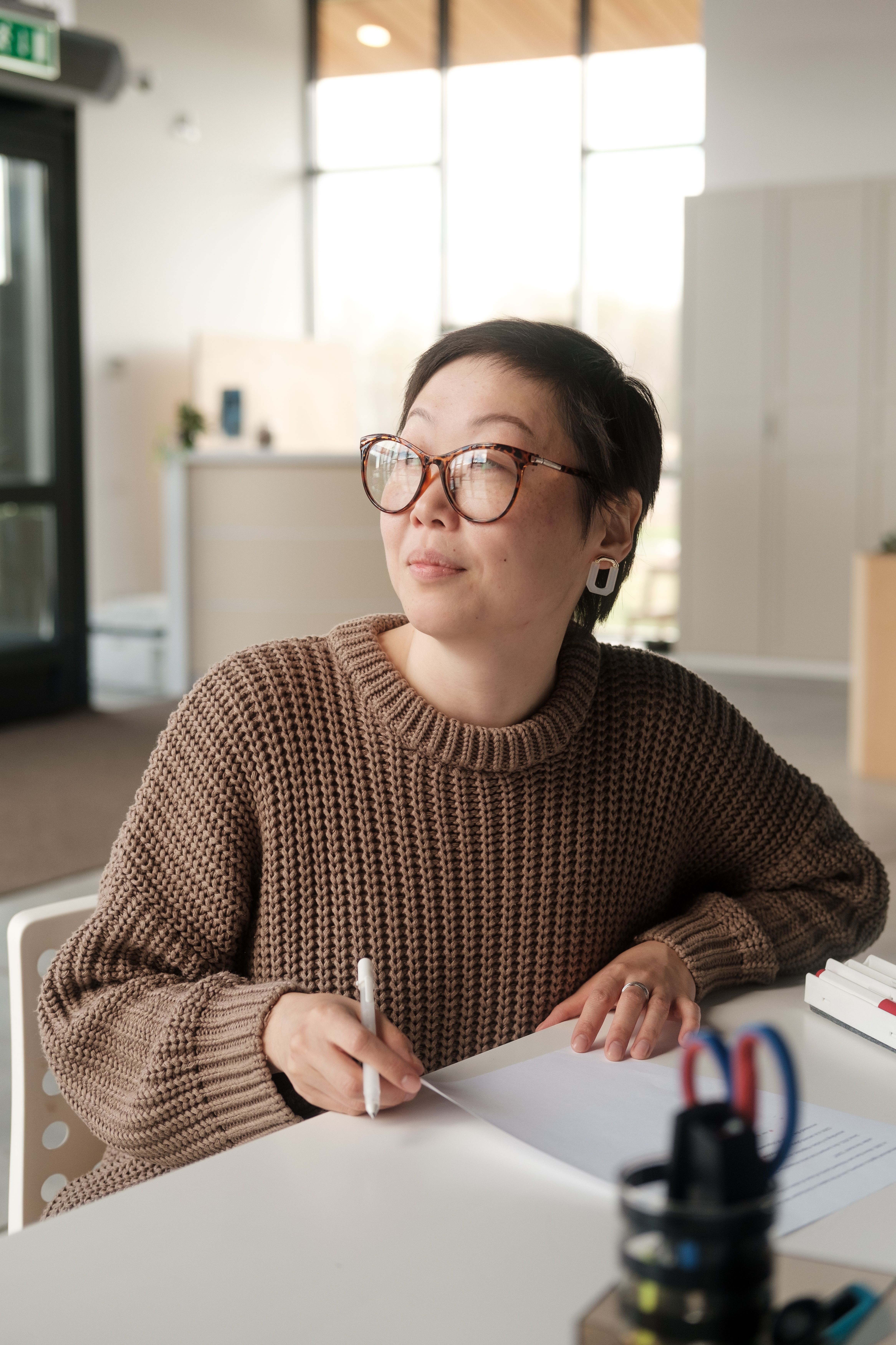 Woman Sitting by Table at Work · Free Stock Photo