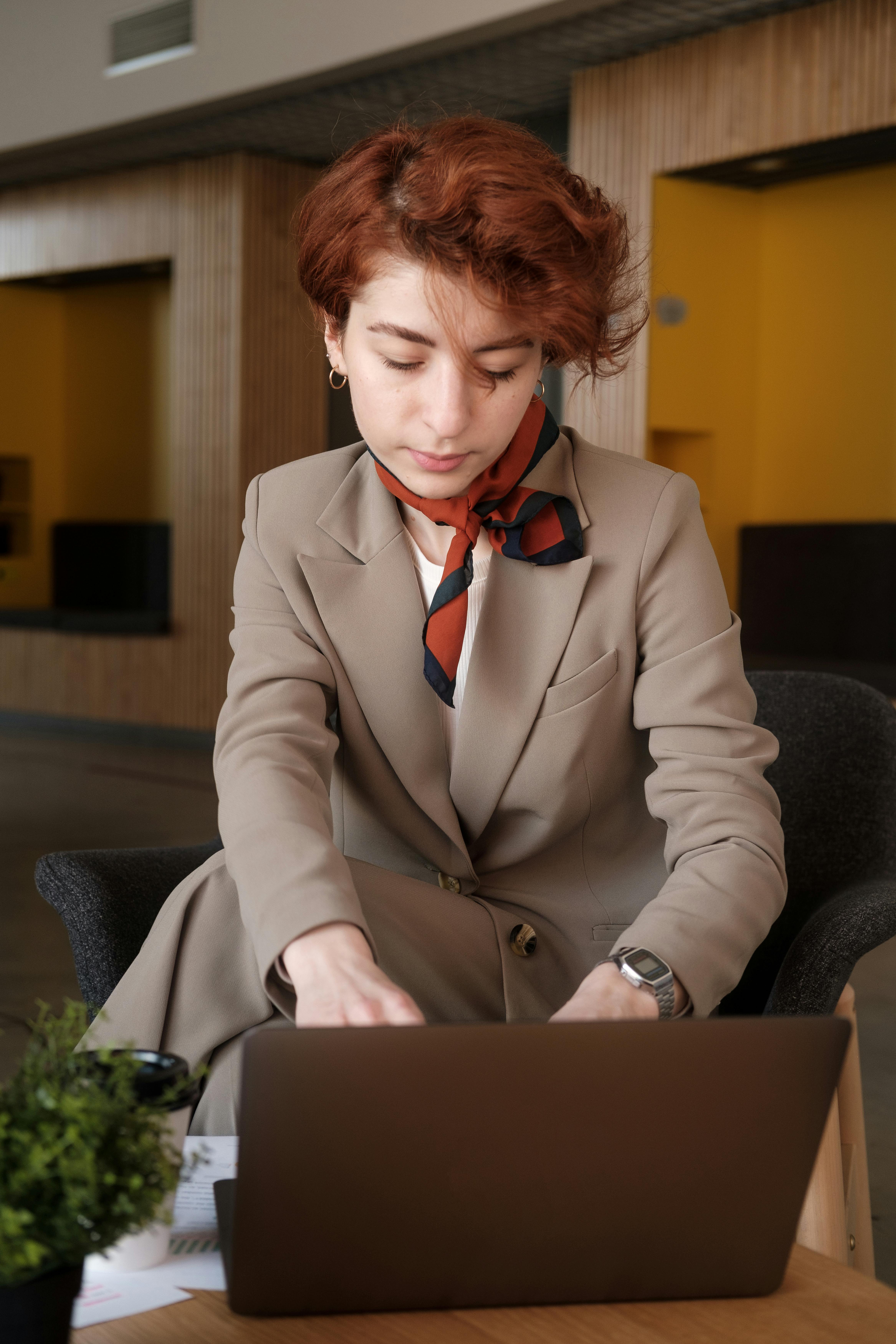 Woman in Formal Clothing Using Laptop in an Office · Free Stock Photo