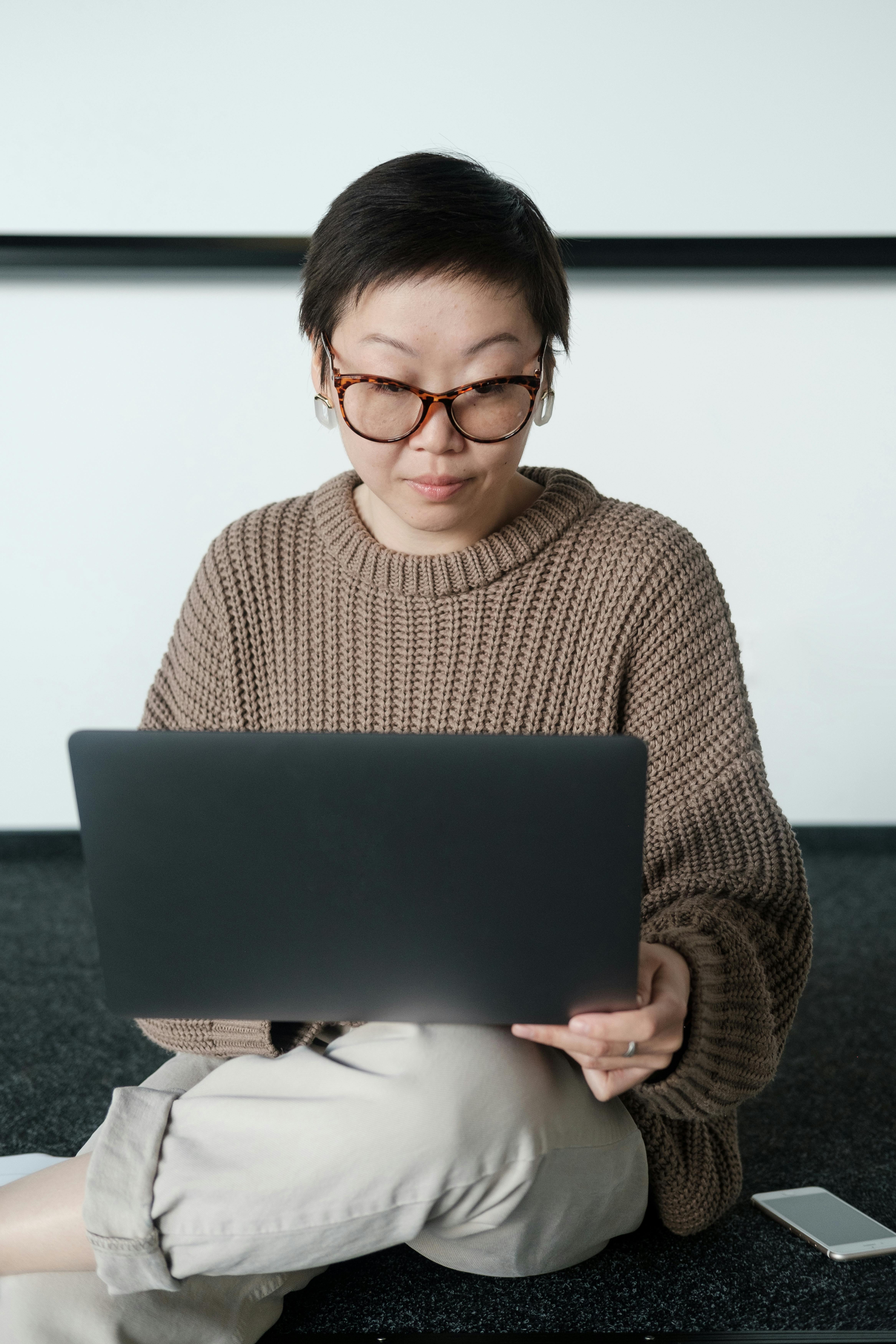 A Woman Sitting with a Laptop · Free Stock Photo