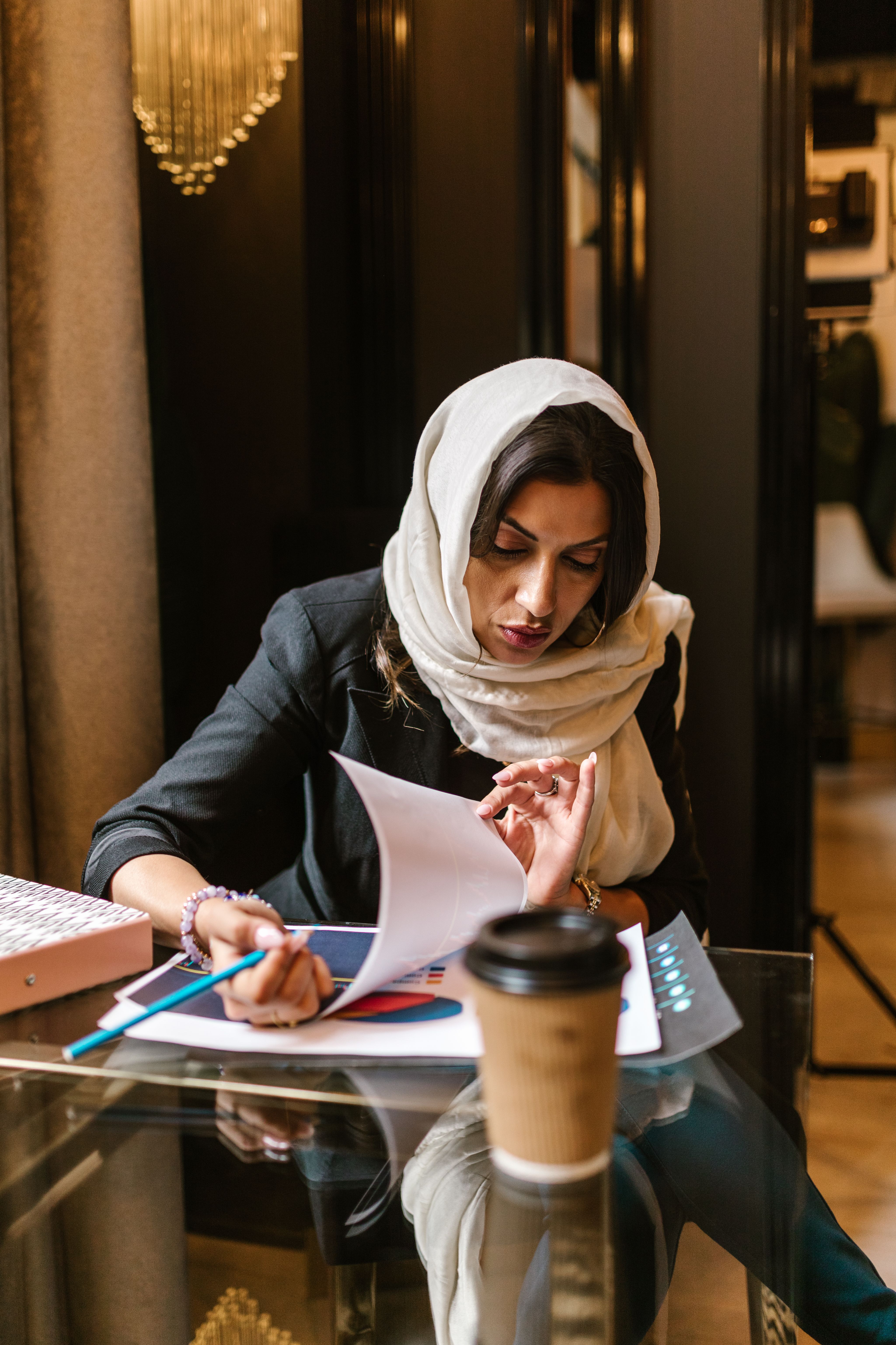 Woman in White Hijab Looking at the Papers · Free Stock Photo