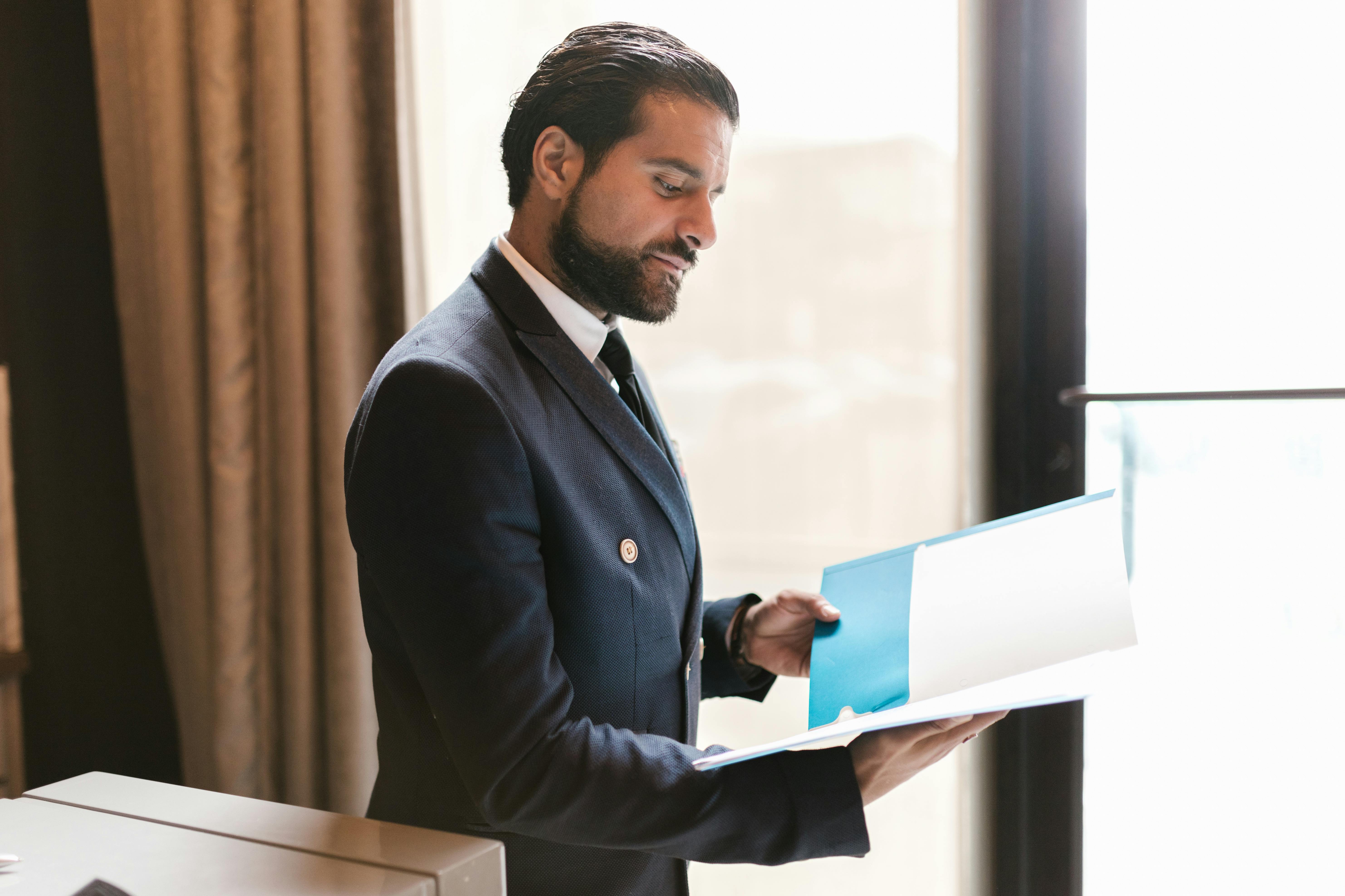 Man in Black Suit Holding a Folder · Free Stock Photo