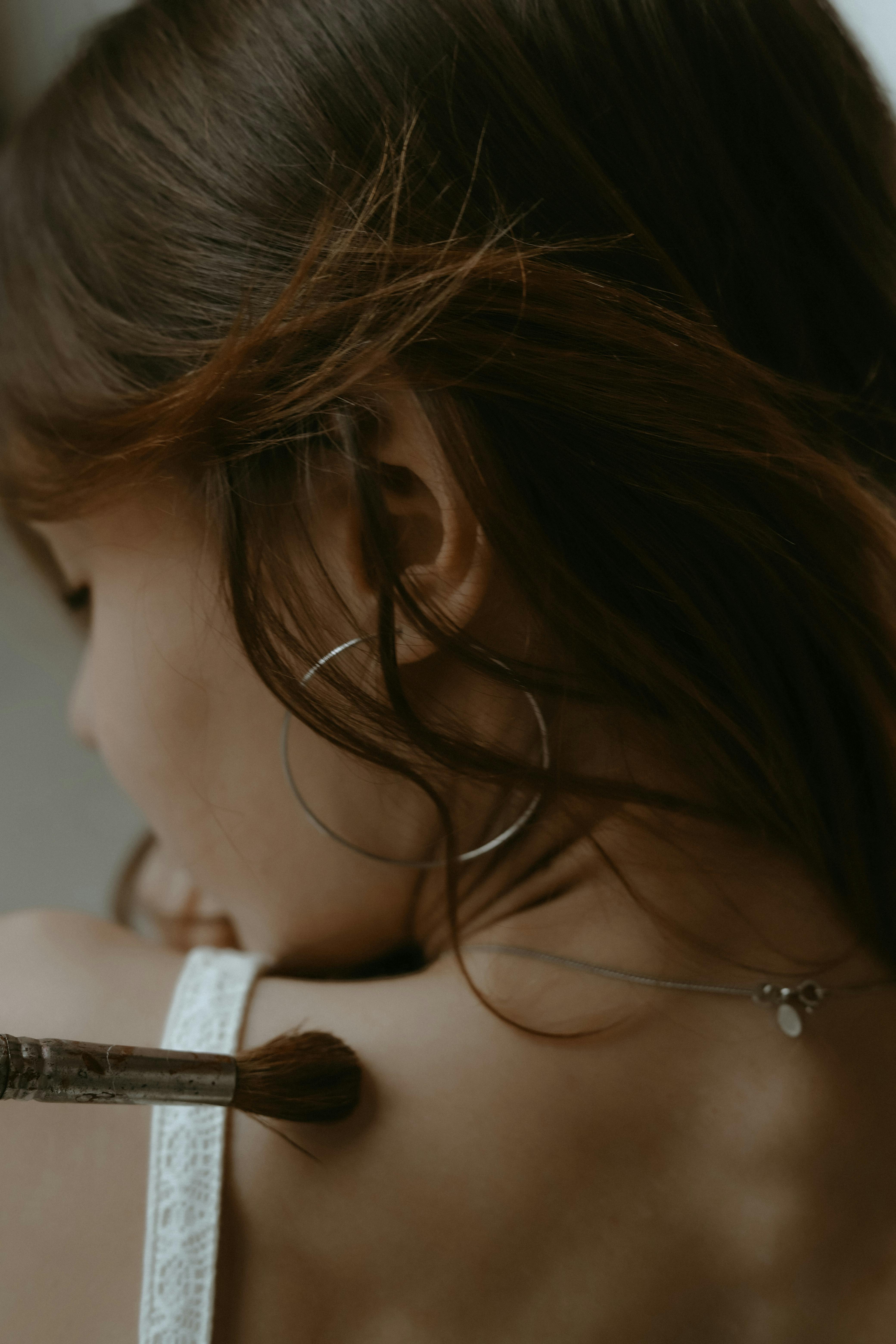Back View of a Woman Wearing Loop Earring · Free Stock Photo