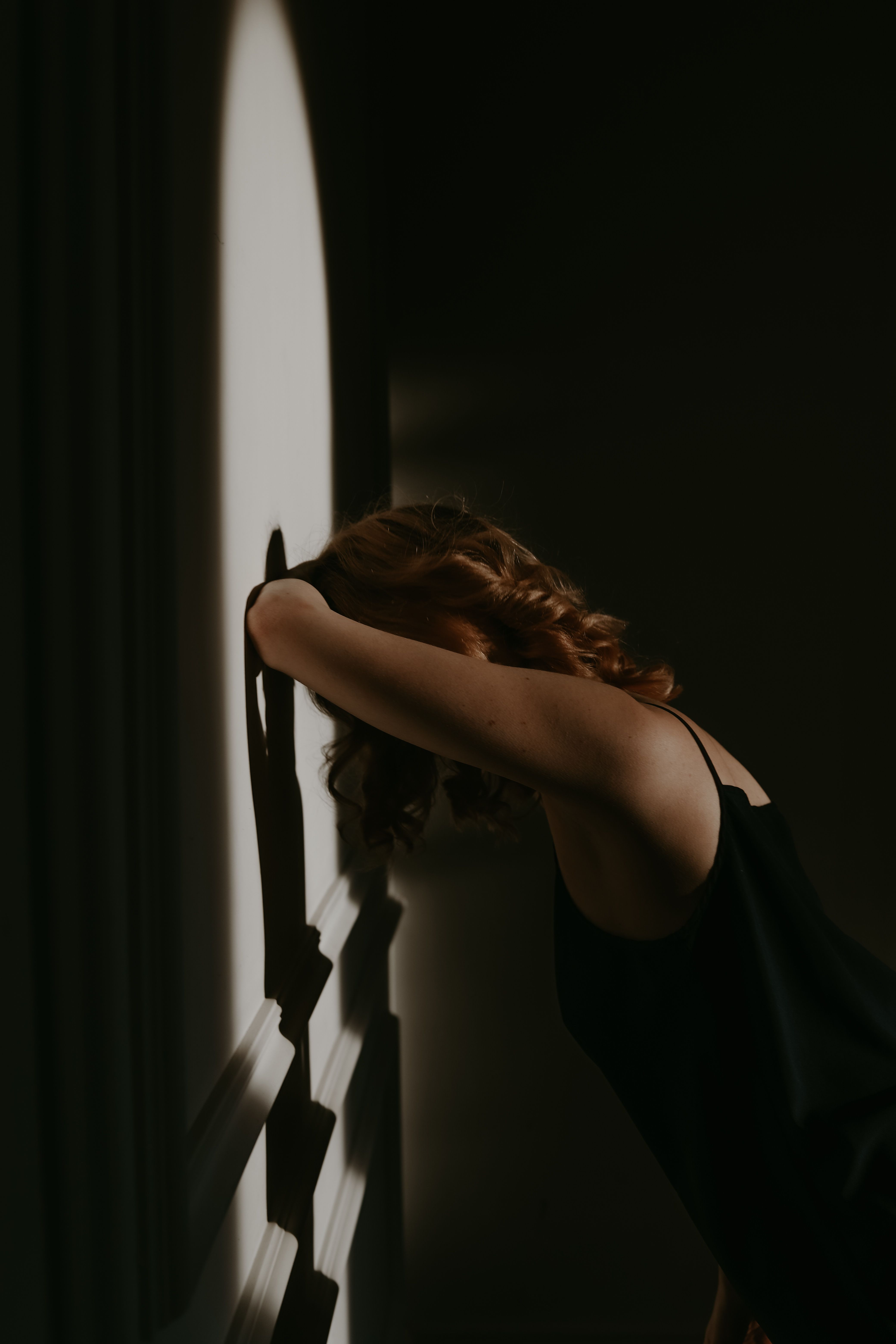 Woman Lying Leaning Against the Wall and Smiling · Free Stock Photo