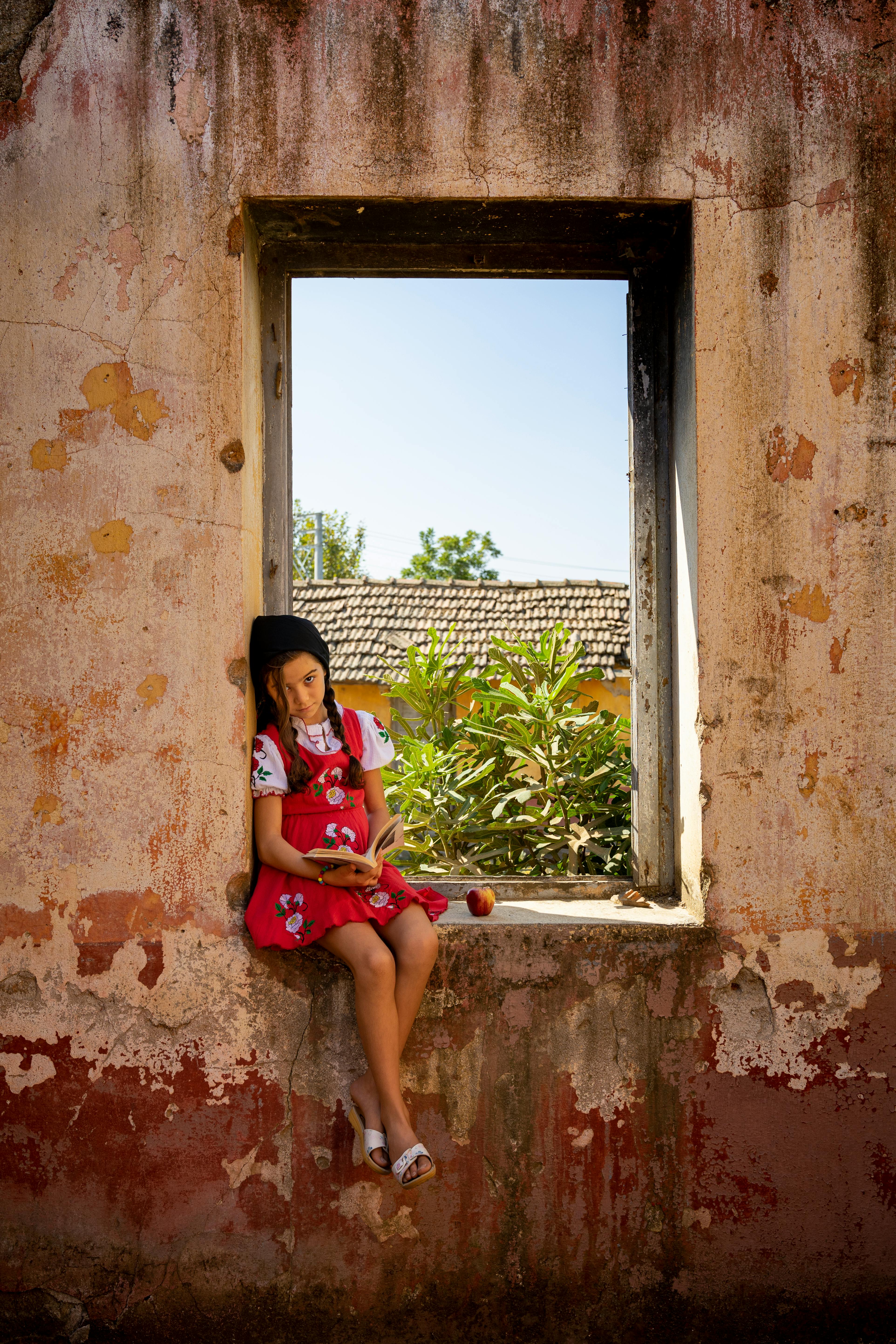 Children Sitting on a Window Ledge · Free Stock Photo