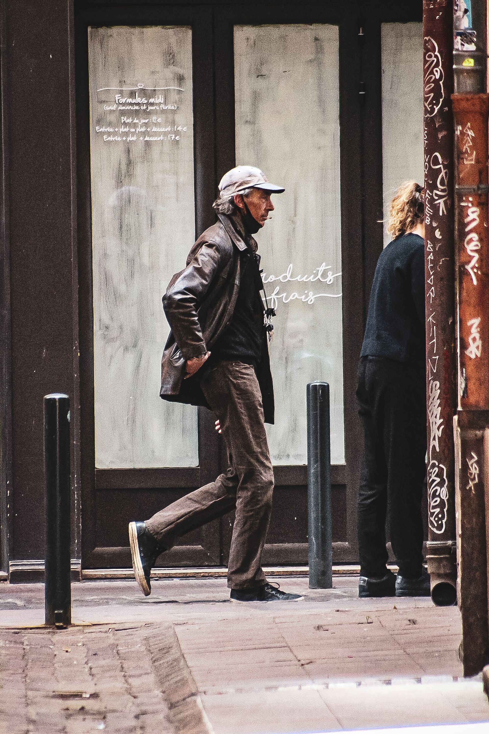 Man in Black Cap Walking on the Street · Free Stock Photo