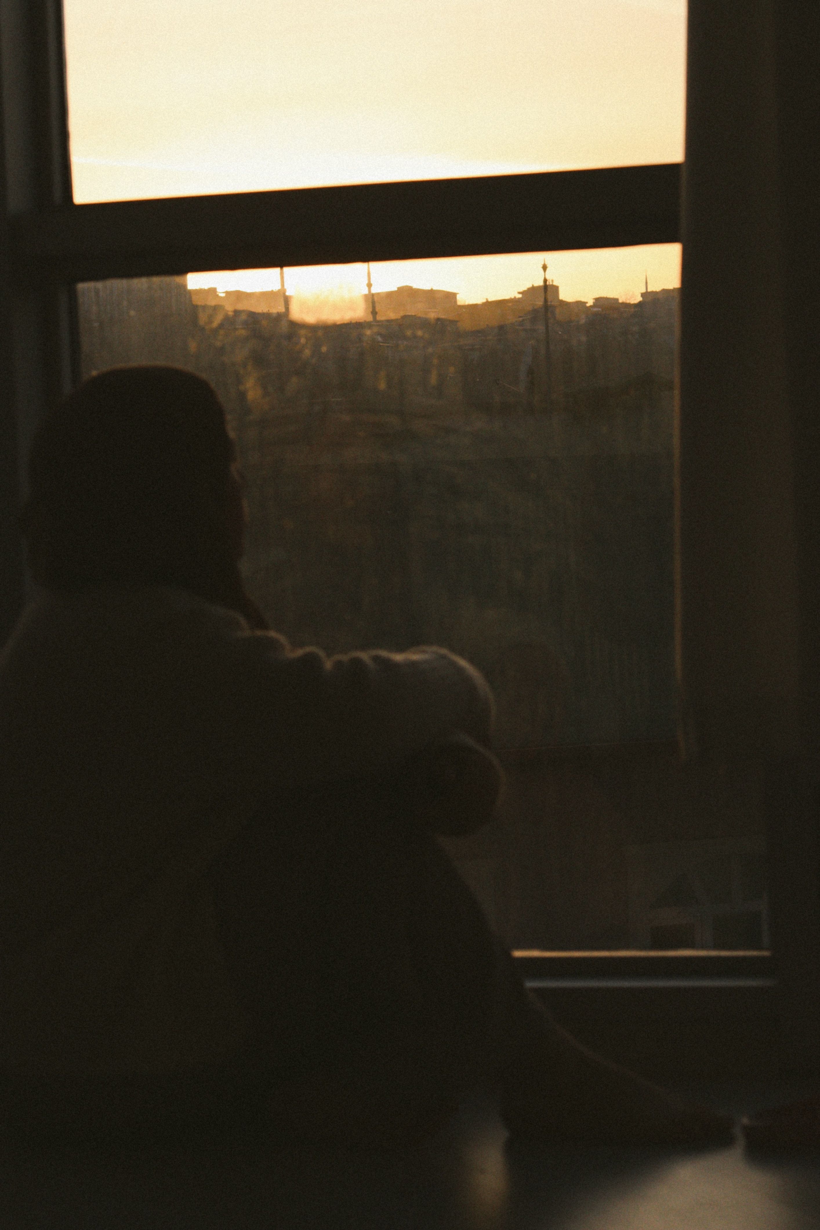 Silhouette of Person Sitting Near the Window · Free Stock Photo