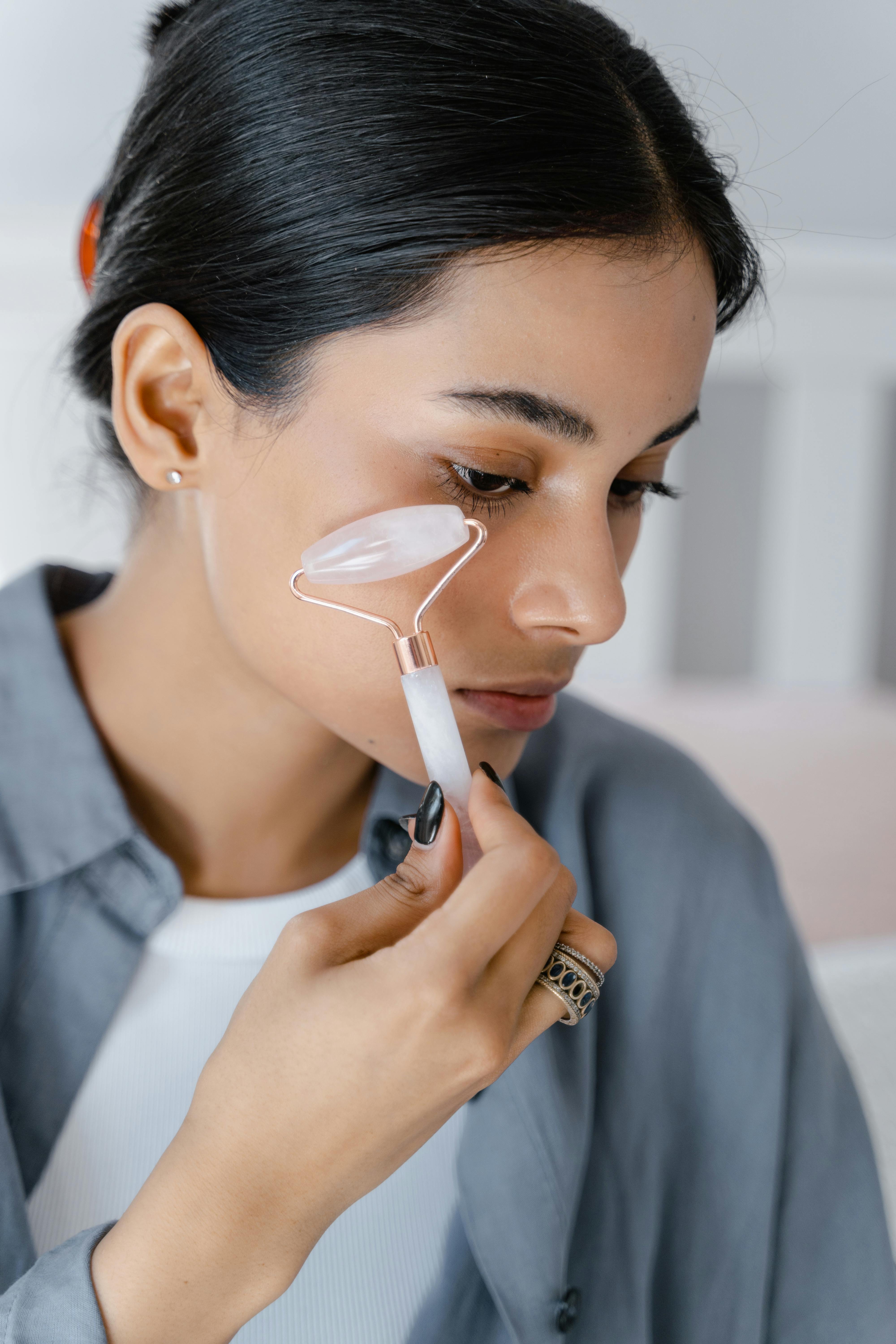 Woman Using Facial Roller · Free Stock Photo