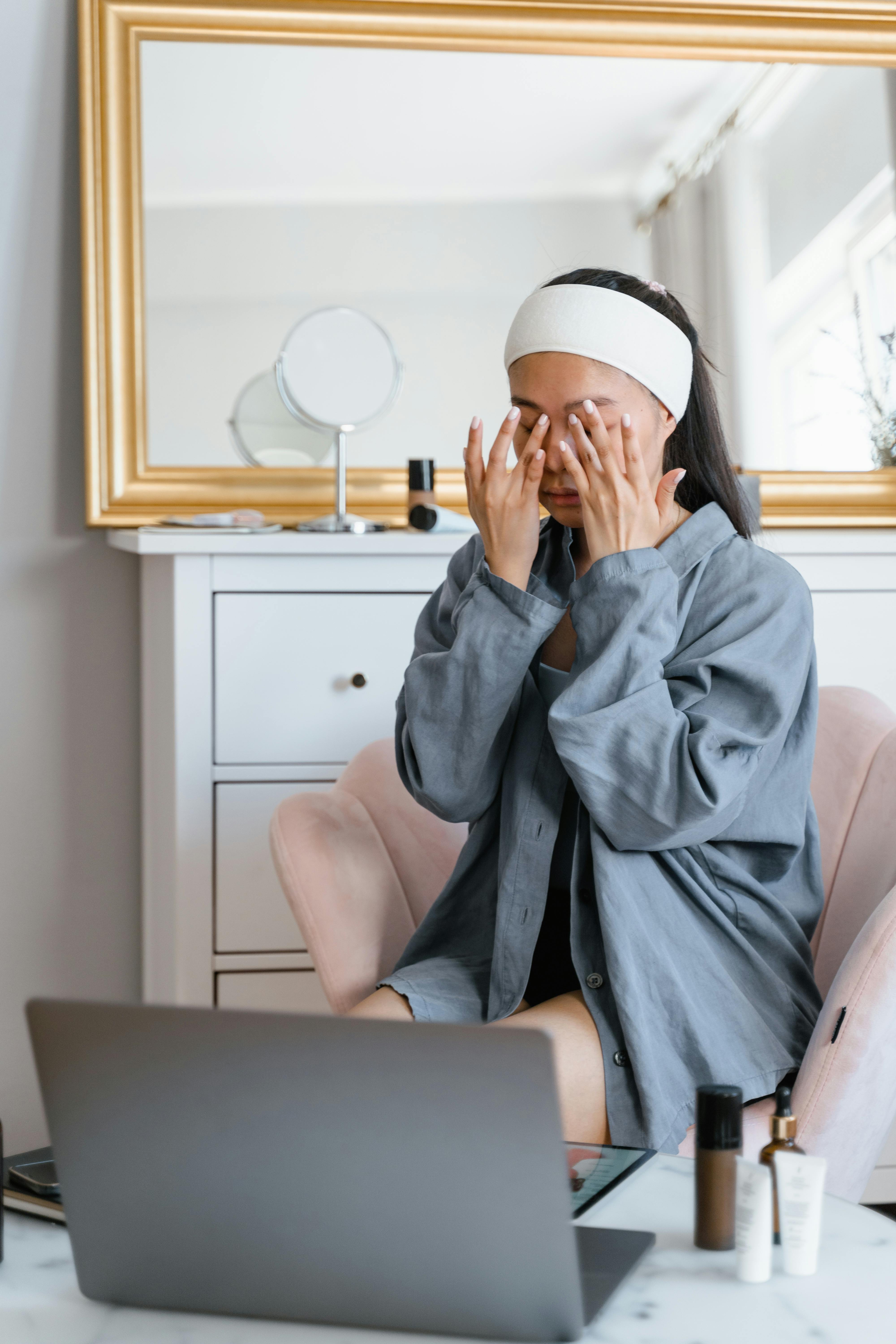 Woman in Oversized Long Sleeves Touching her Eyelids · Free Stock Photo