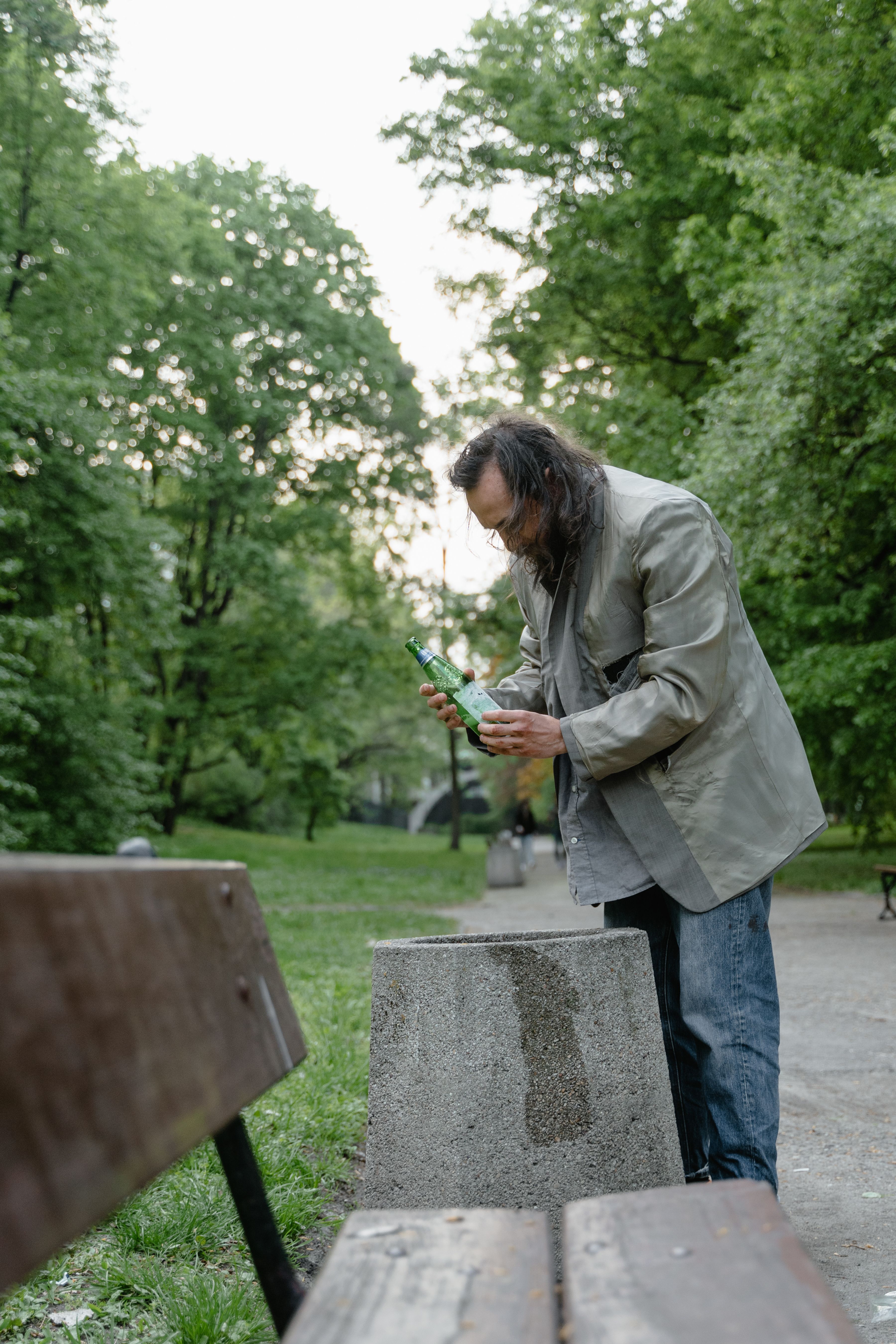 Man Holding a Green Glass Bottle · Free Stock Photo
