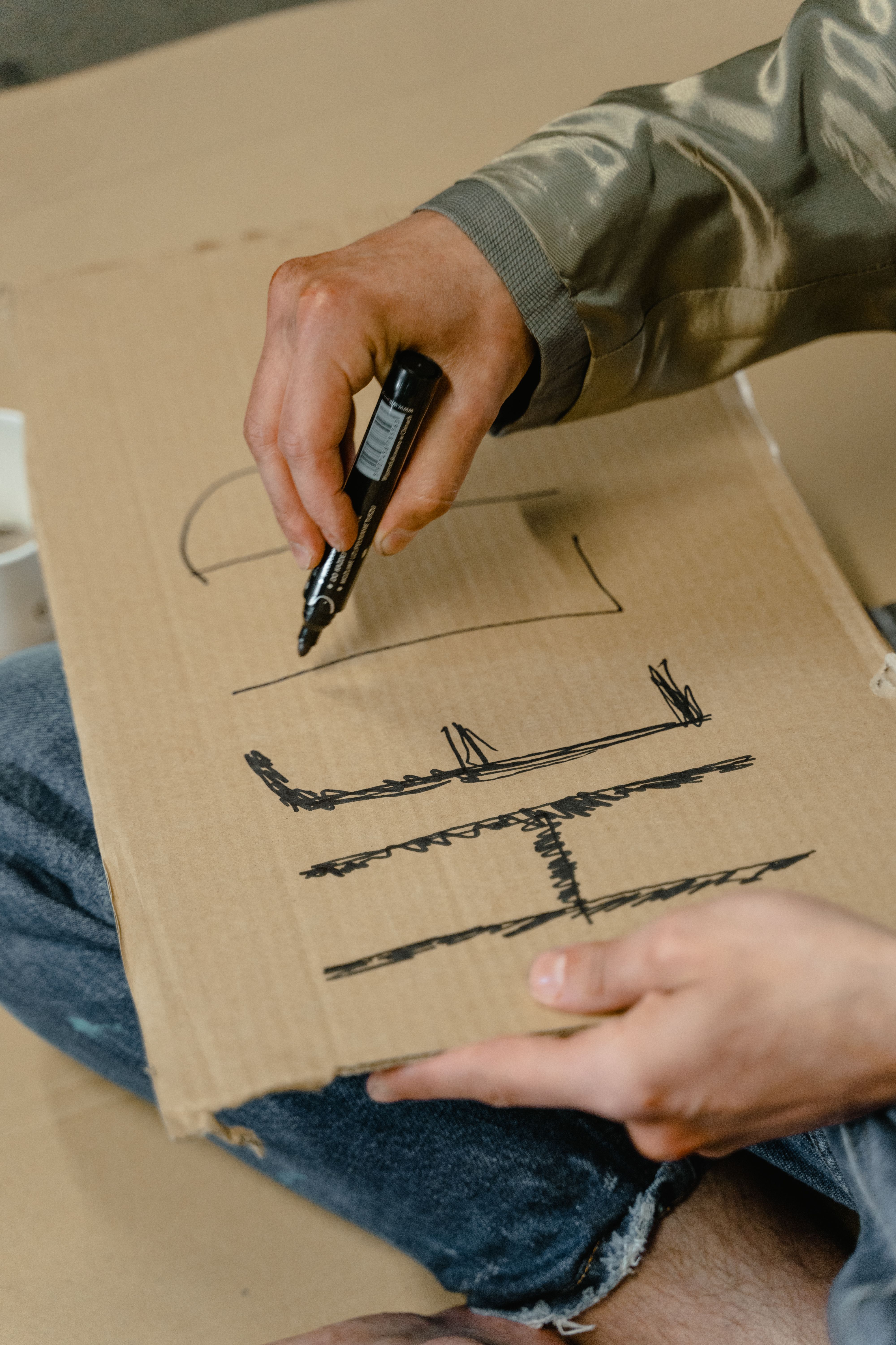 A Person Writing on a Cardboard · Free Stock Photo