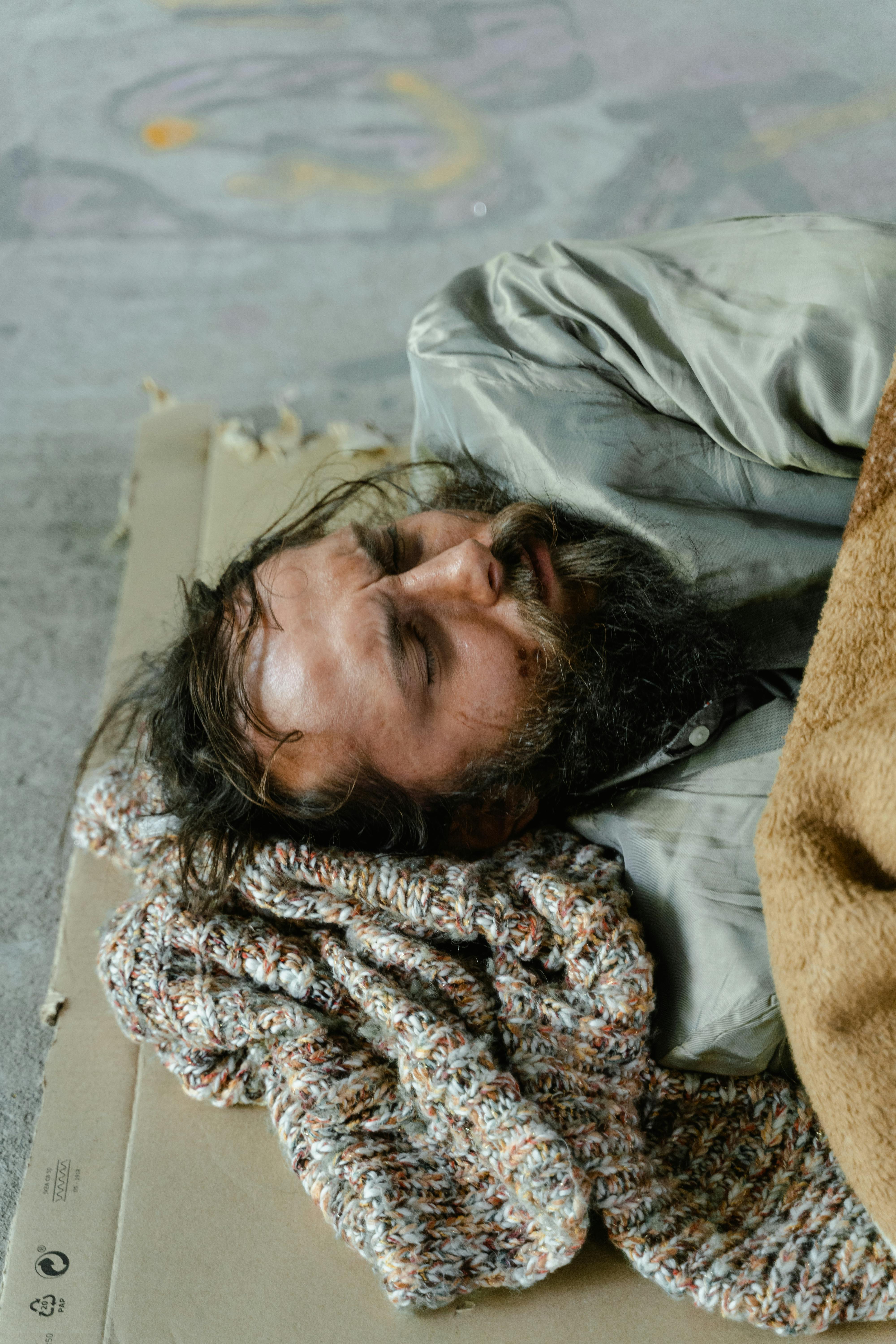 A Male Beggar Sleeping on the Street · Free Stock Photo