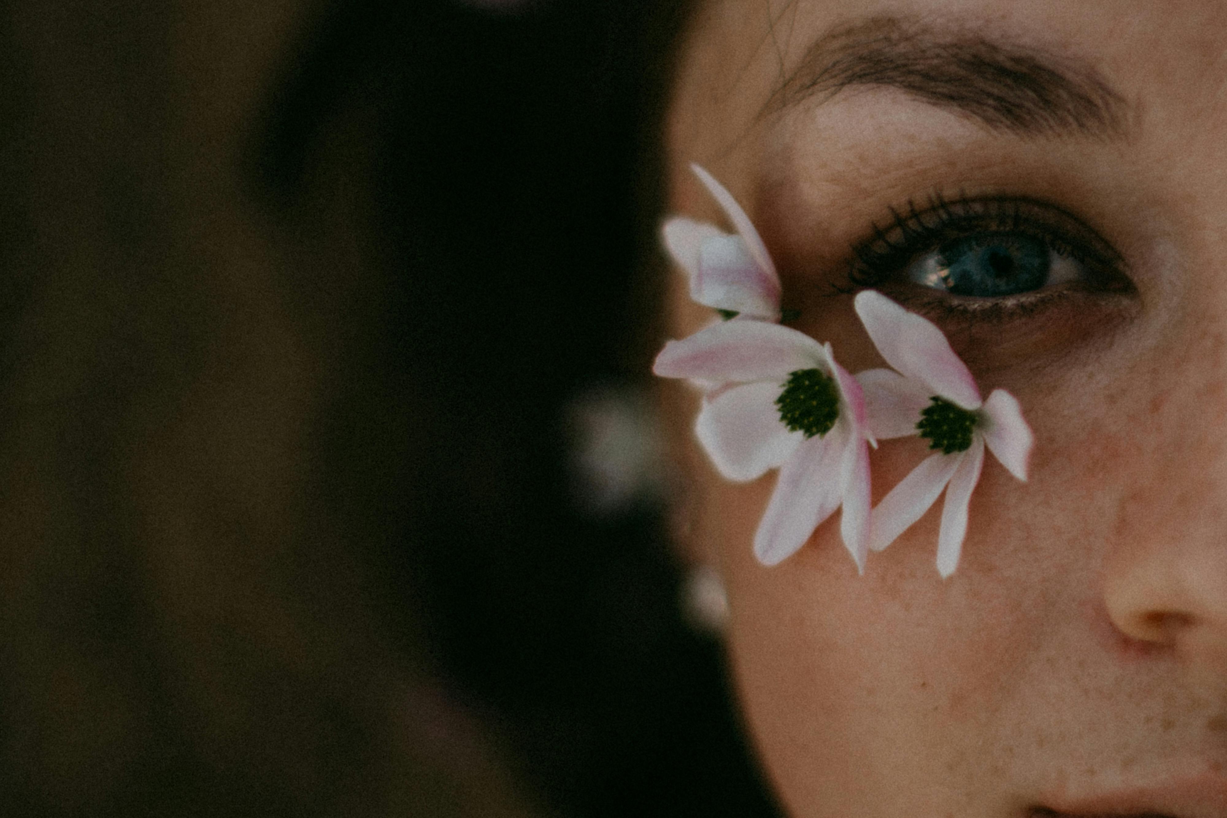 Close-up of Flowers under the Eye of a Woman · Free Stock Photo
