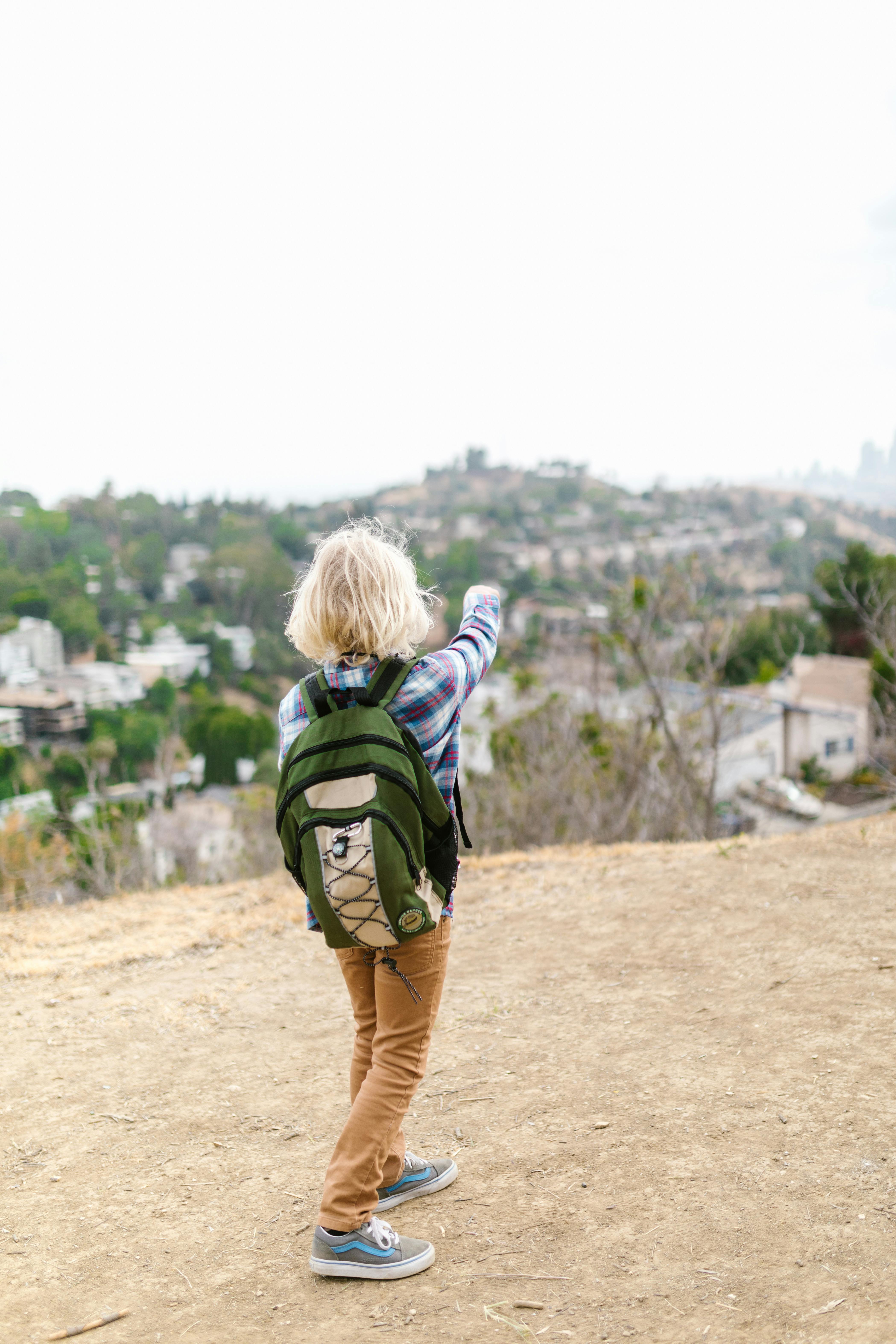 Boy in Green Backpack Finger Pointing · Free Stock Photo