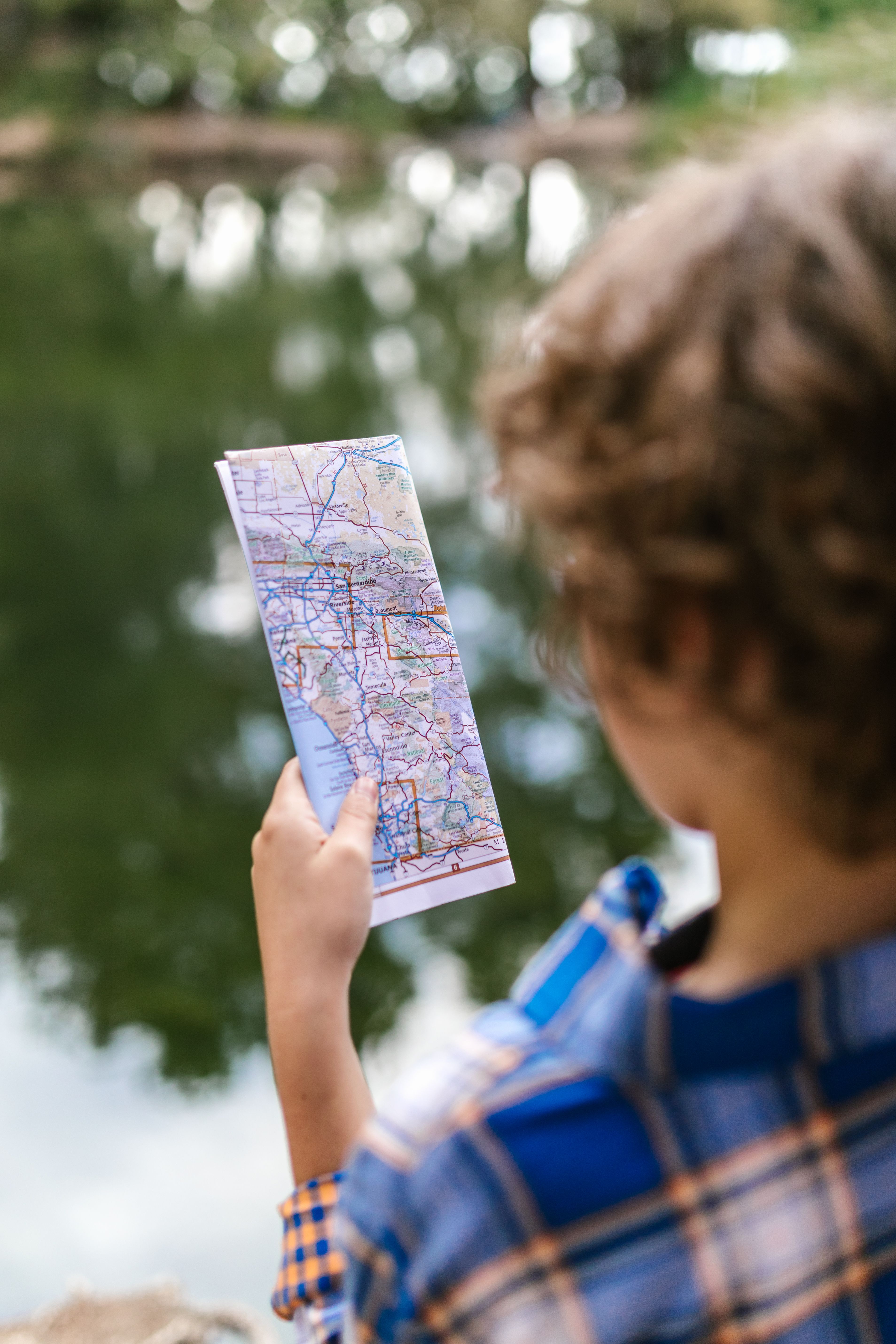 Boy Looking at World Map and Compass · Free Stock Photo