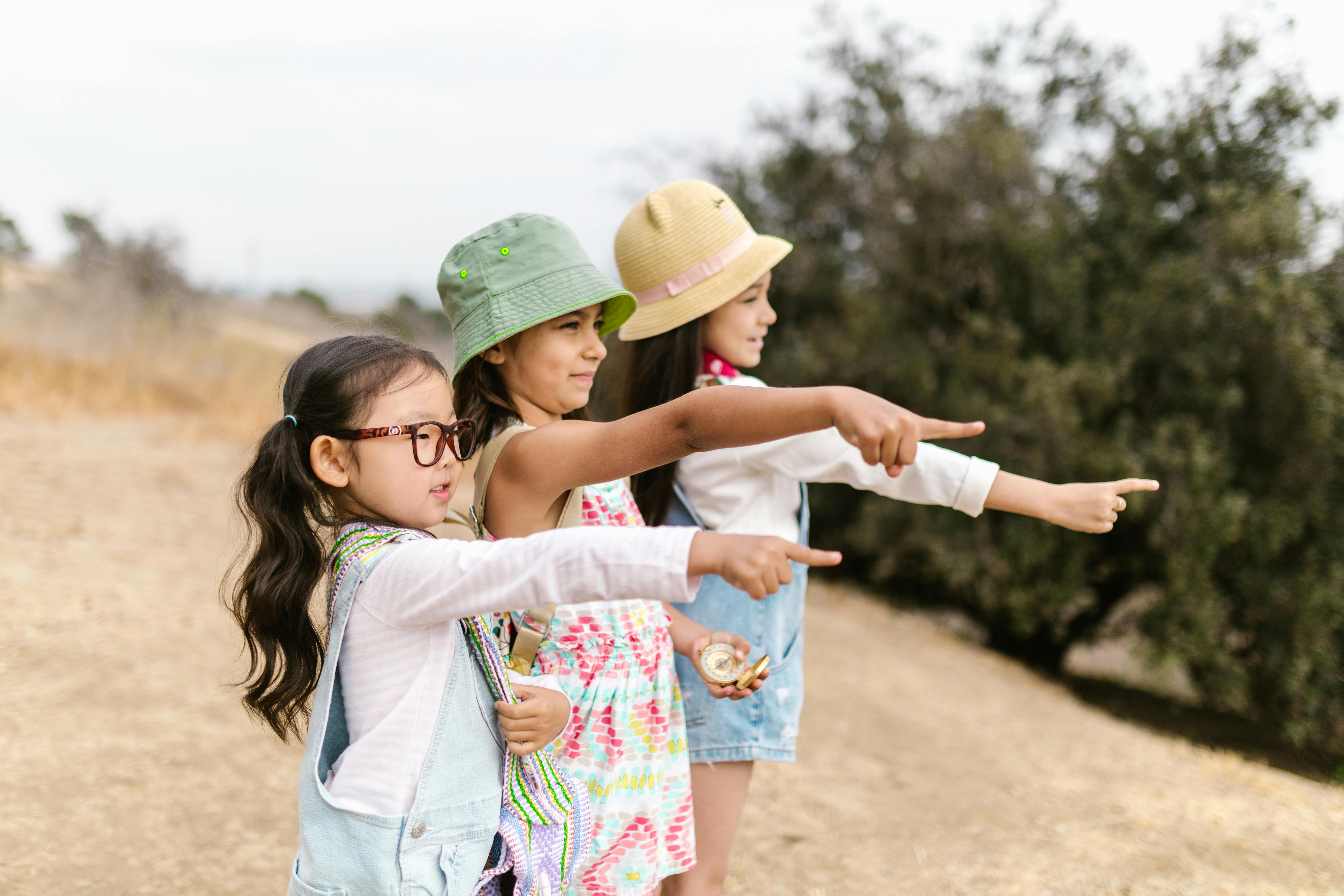 Three Girls Lined Up Finger Pointing Forward · Free Stock Photo