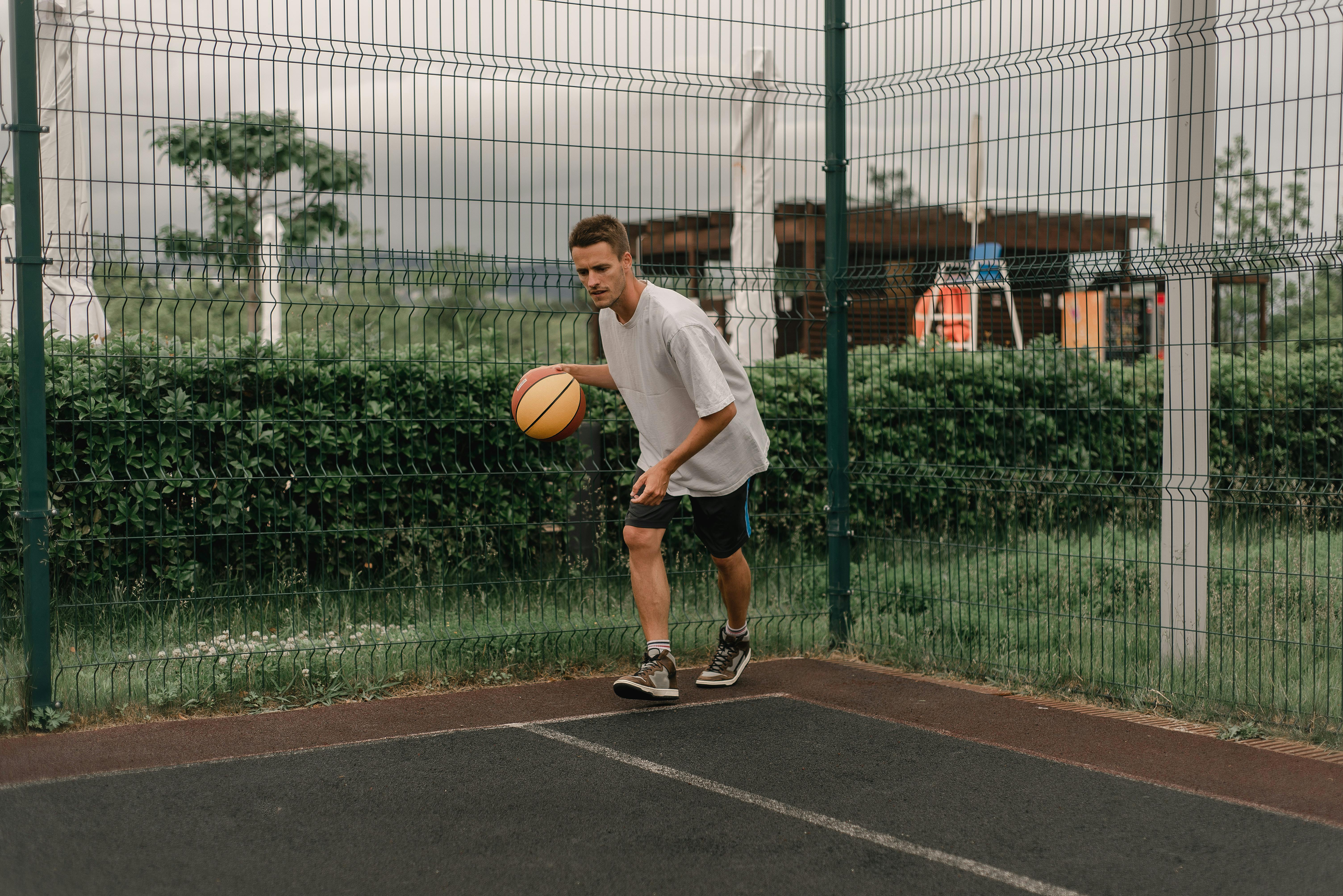 A Man in Active Wear Playing Basketball · Free Stock Photo
