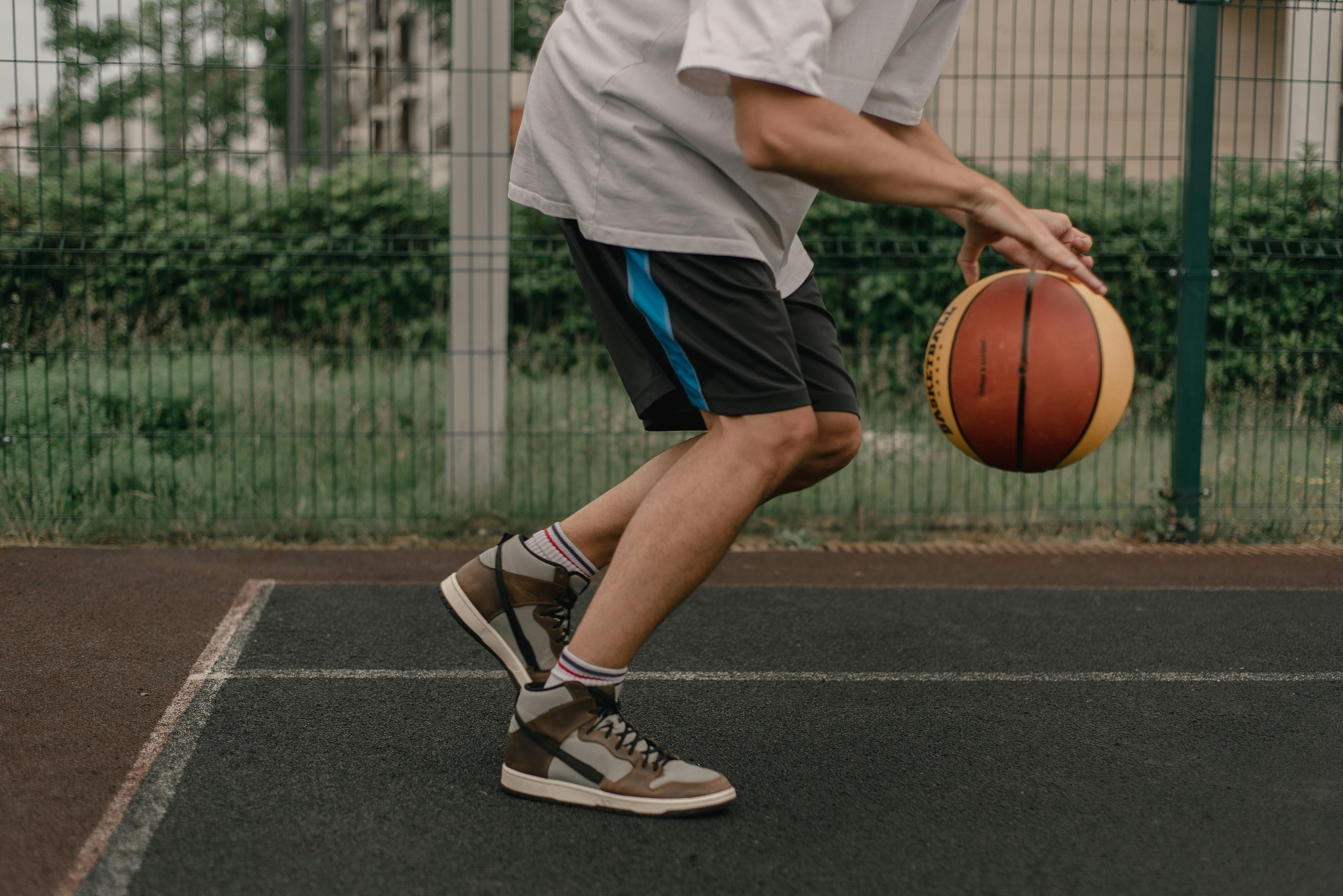 Person Dribbling a Ball · Free Stock Photo