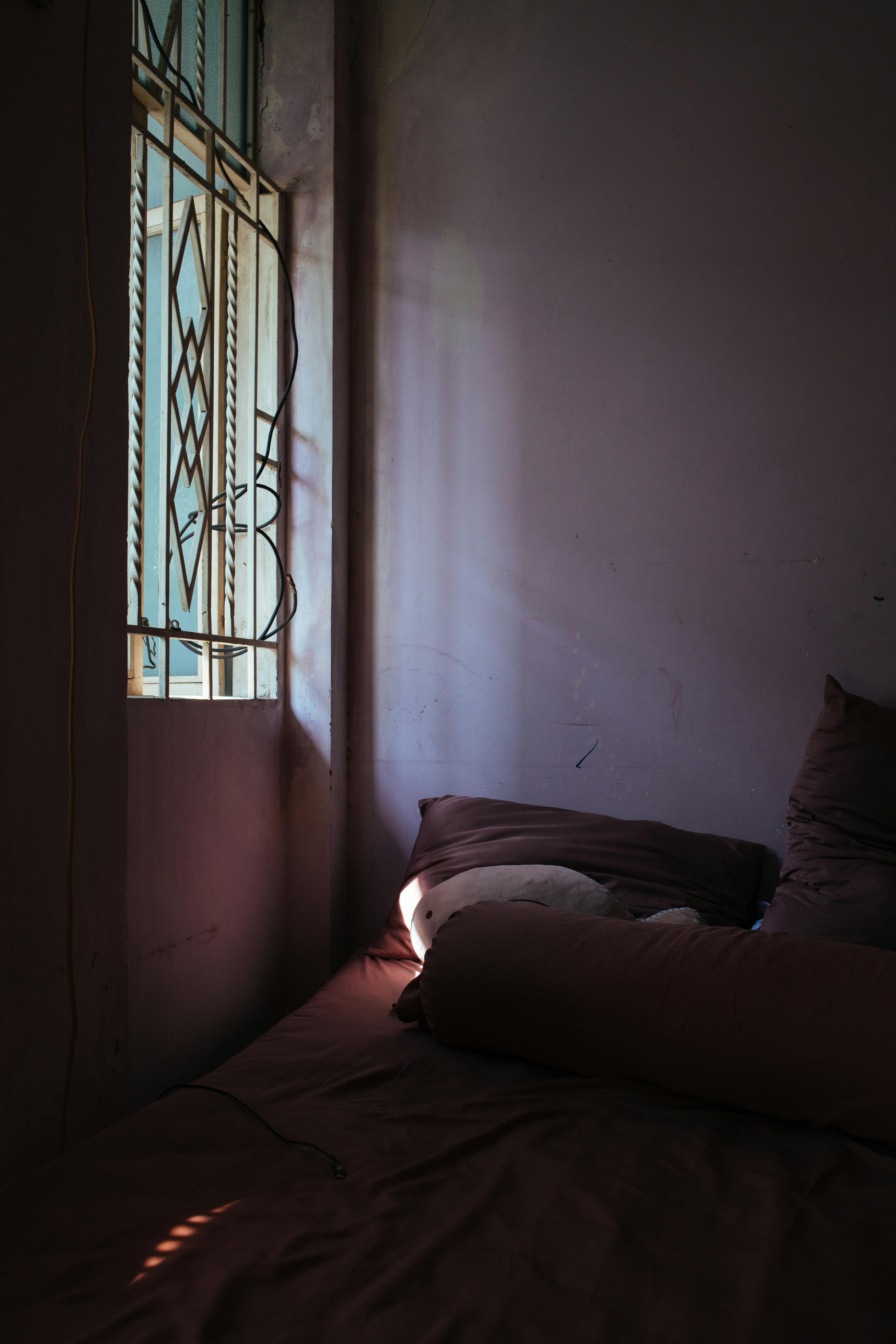 Bed Beside the Concrete Wall · Free Stock Photo