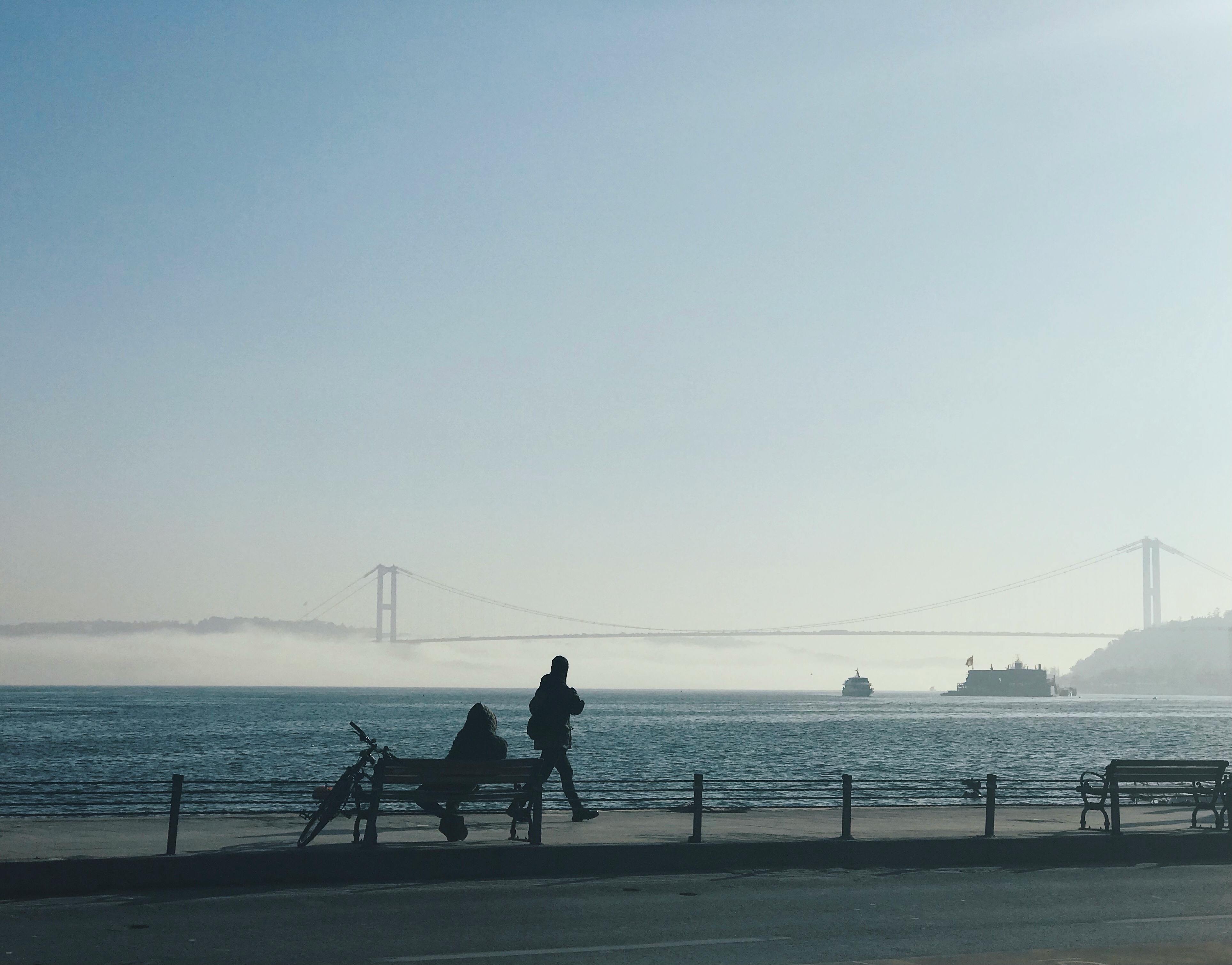 People Sitting on Concrete Bridge · Free Stock Photo