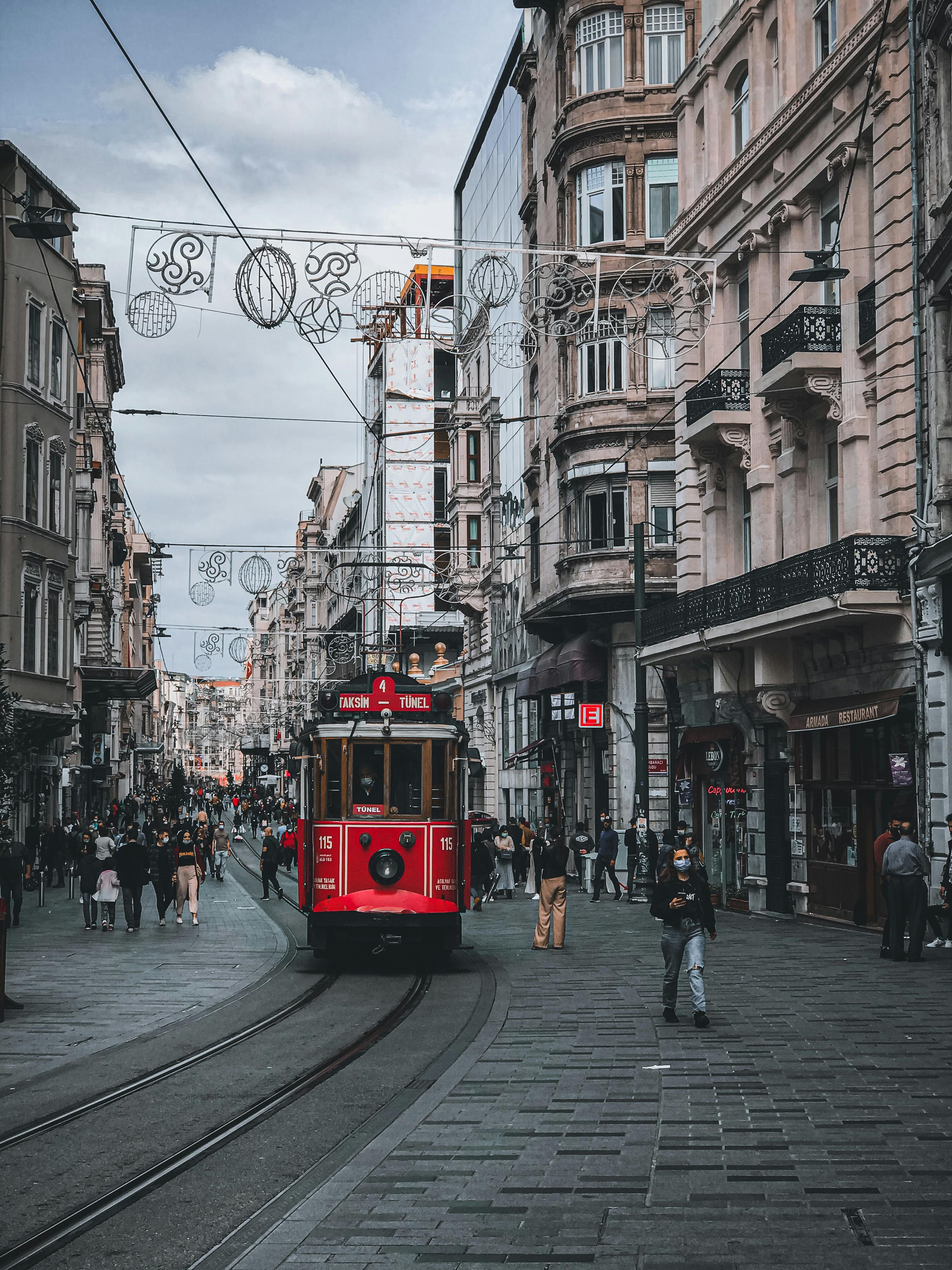 People Walking on Road Near Red Tram · Free Stock Photo
