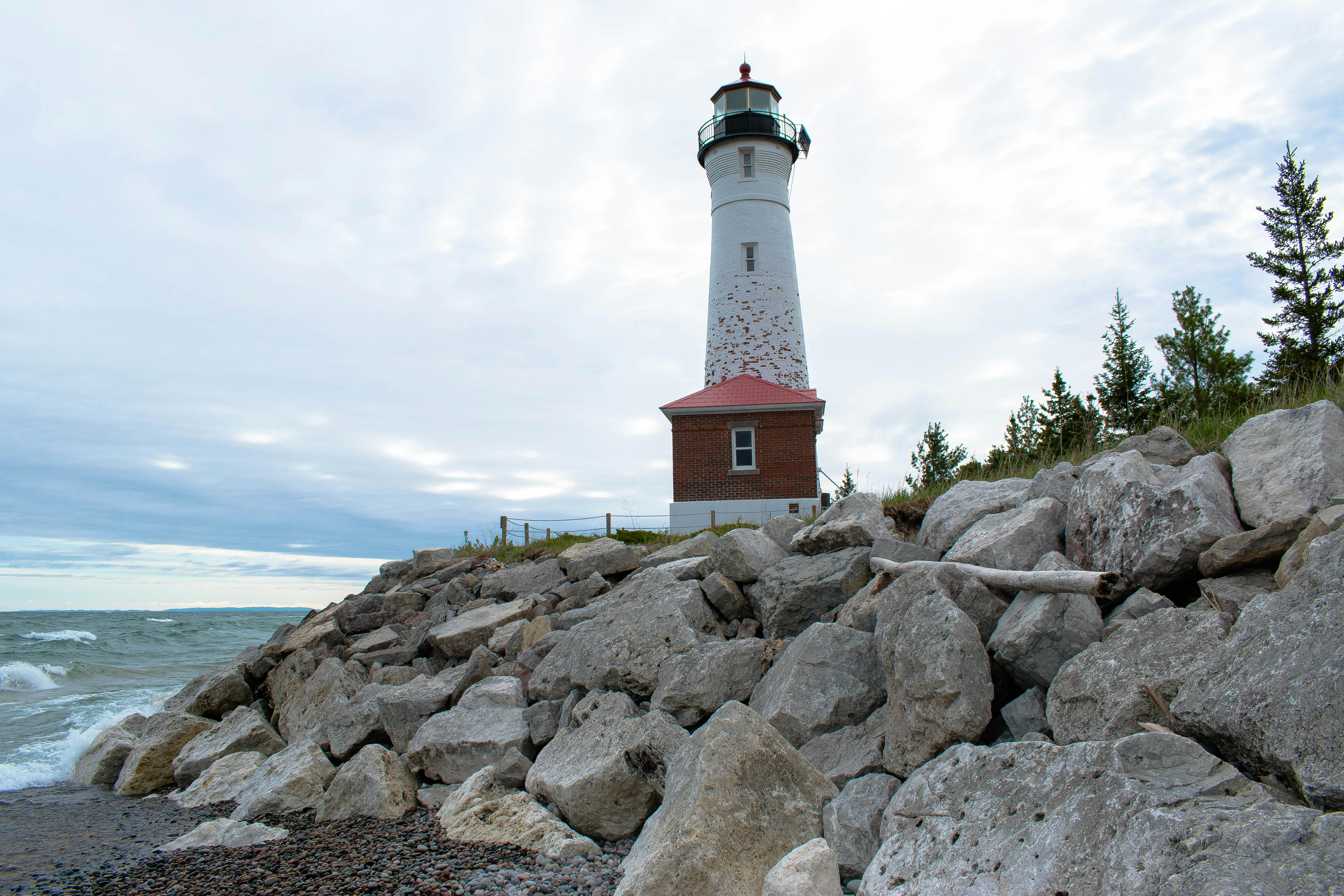 Lighthouse on Cliff near Sea · Free Stock Photo