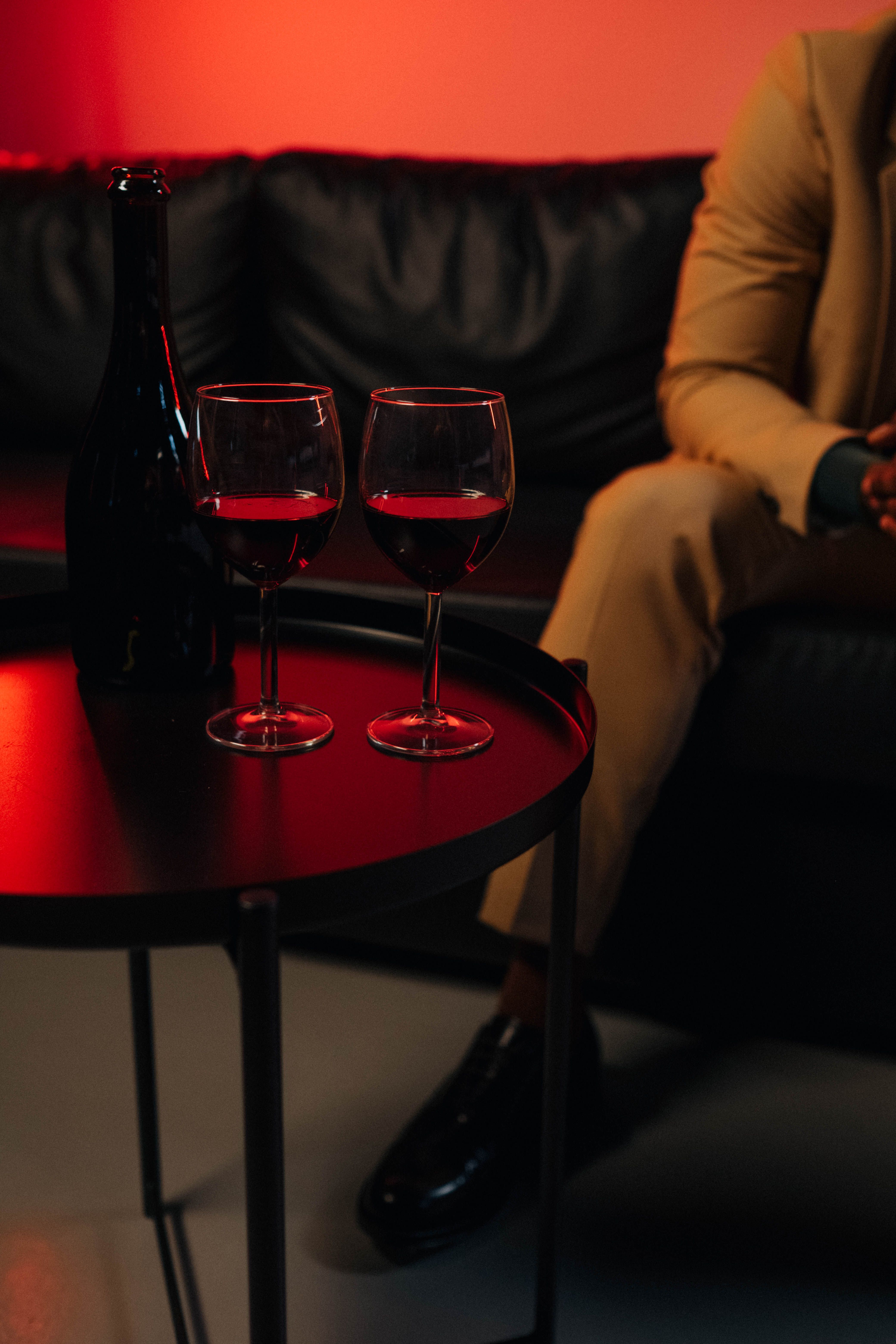 Close-Up Shot of Two Wine Glasses and Bottle of Wine on a Table · Free ...