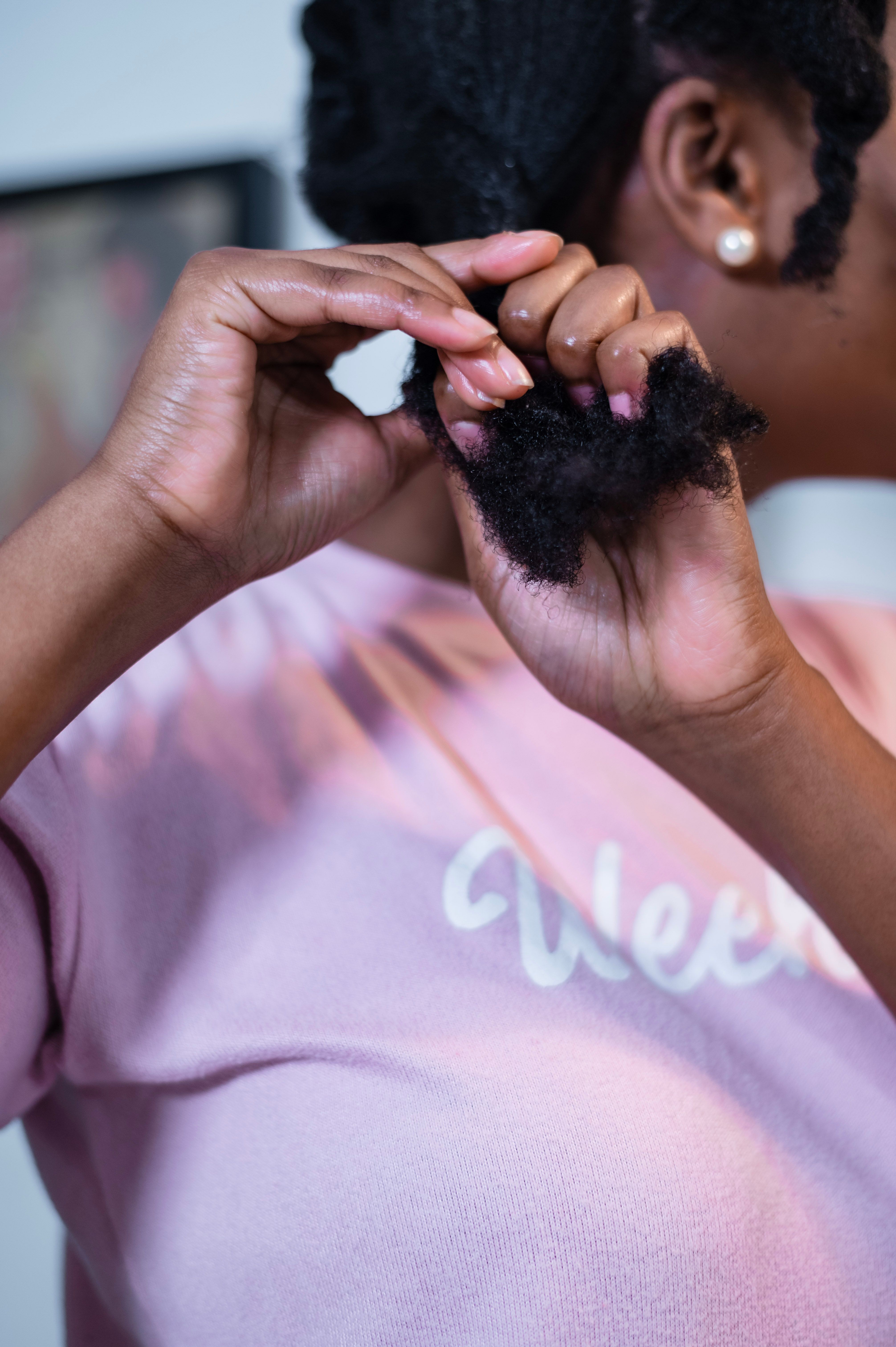 Close Up Photo of Woman Tying Her Hair · Free Stock Photo