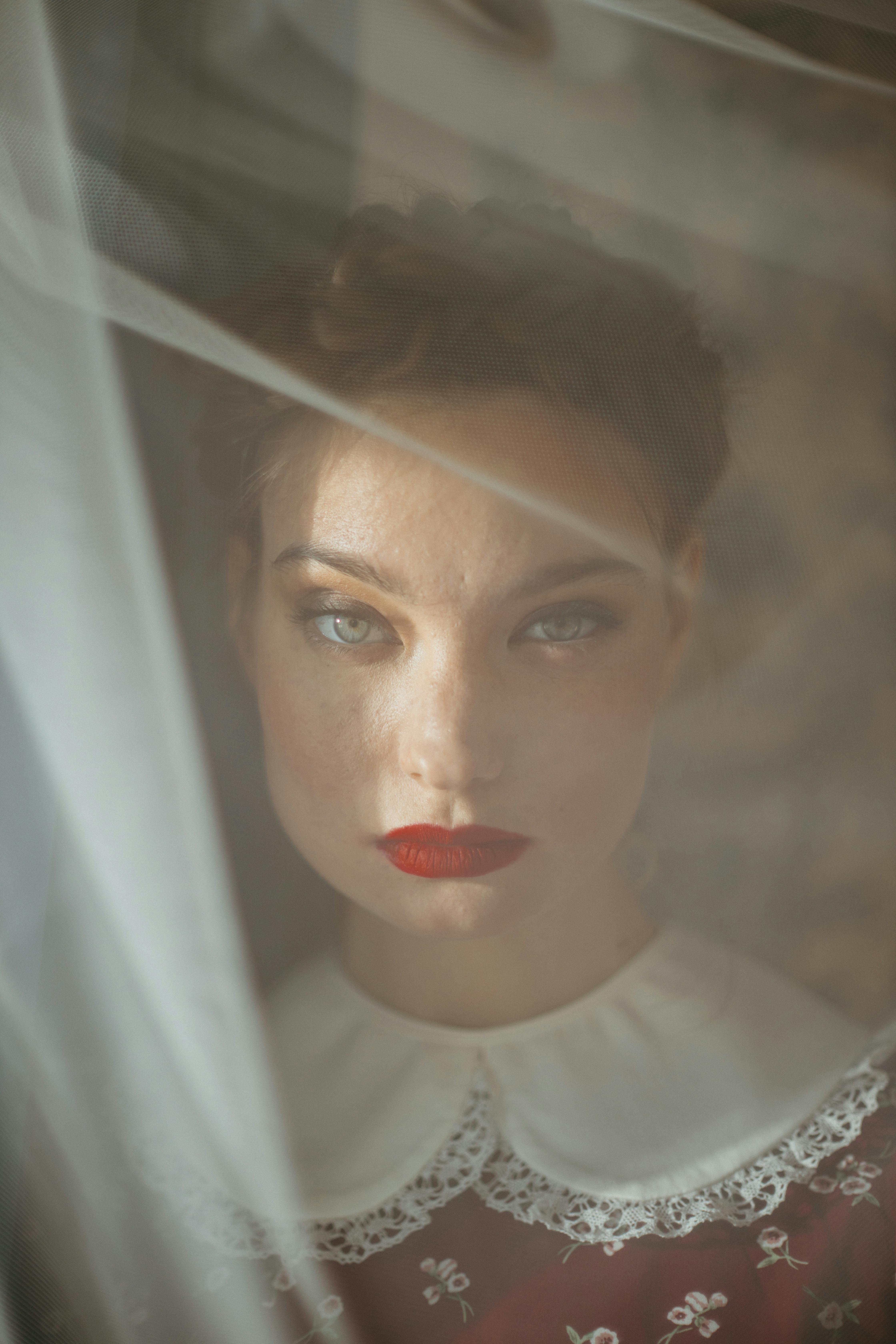 A Woman Looking Behind the Curtain · Free Stock Photo