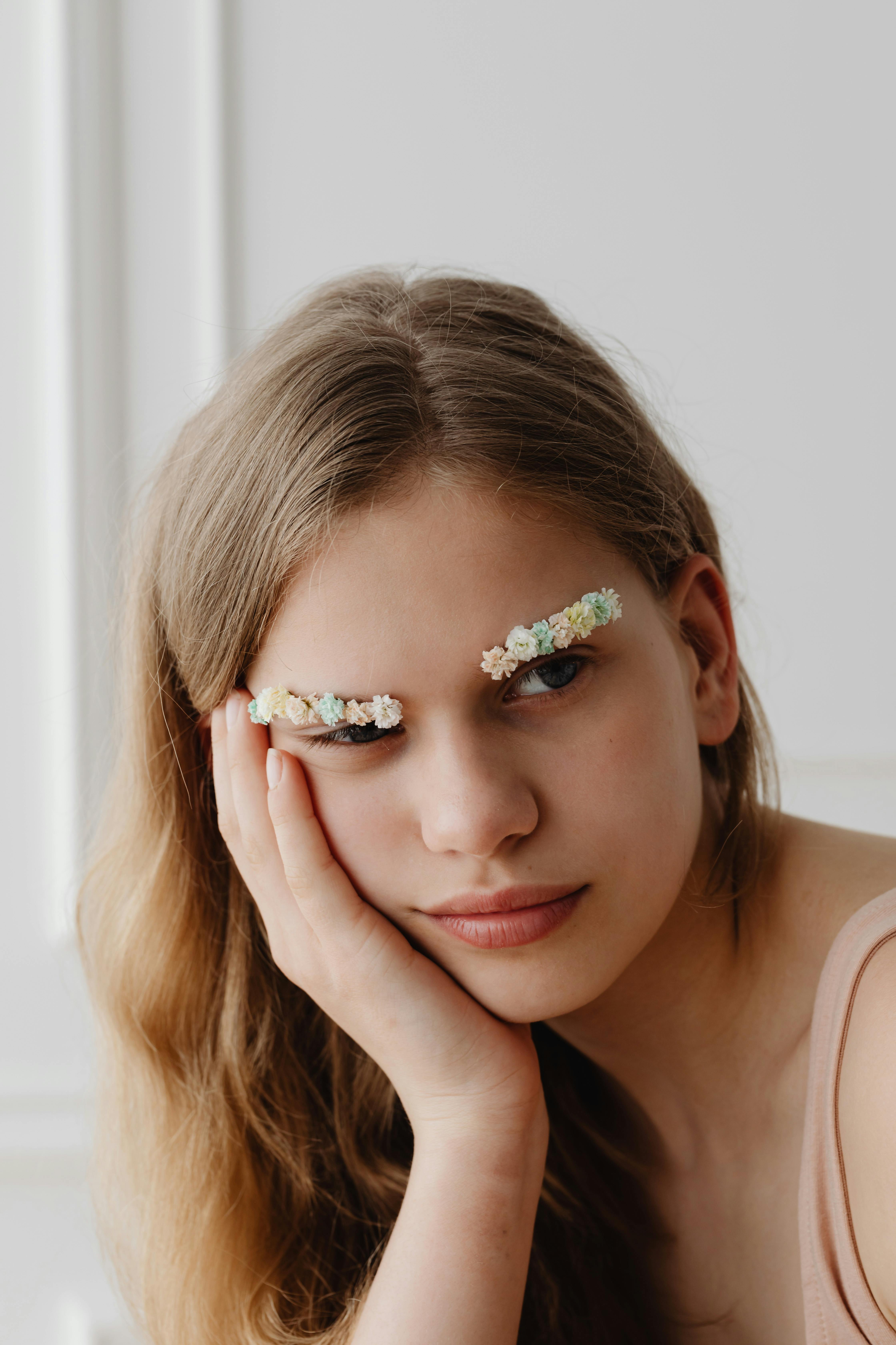A Woman with Flowers on Her Eyebrows · Free Stock Photo