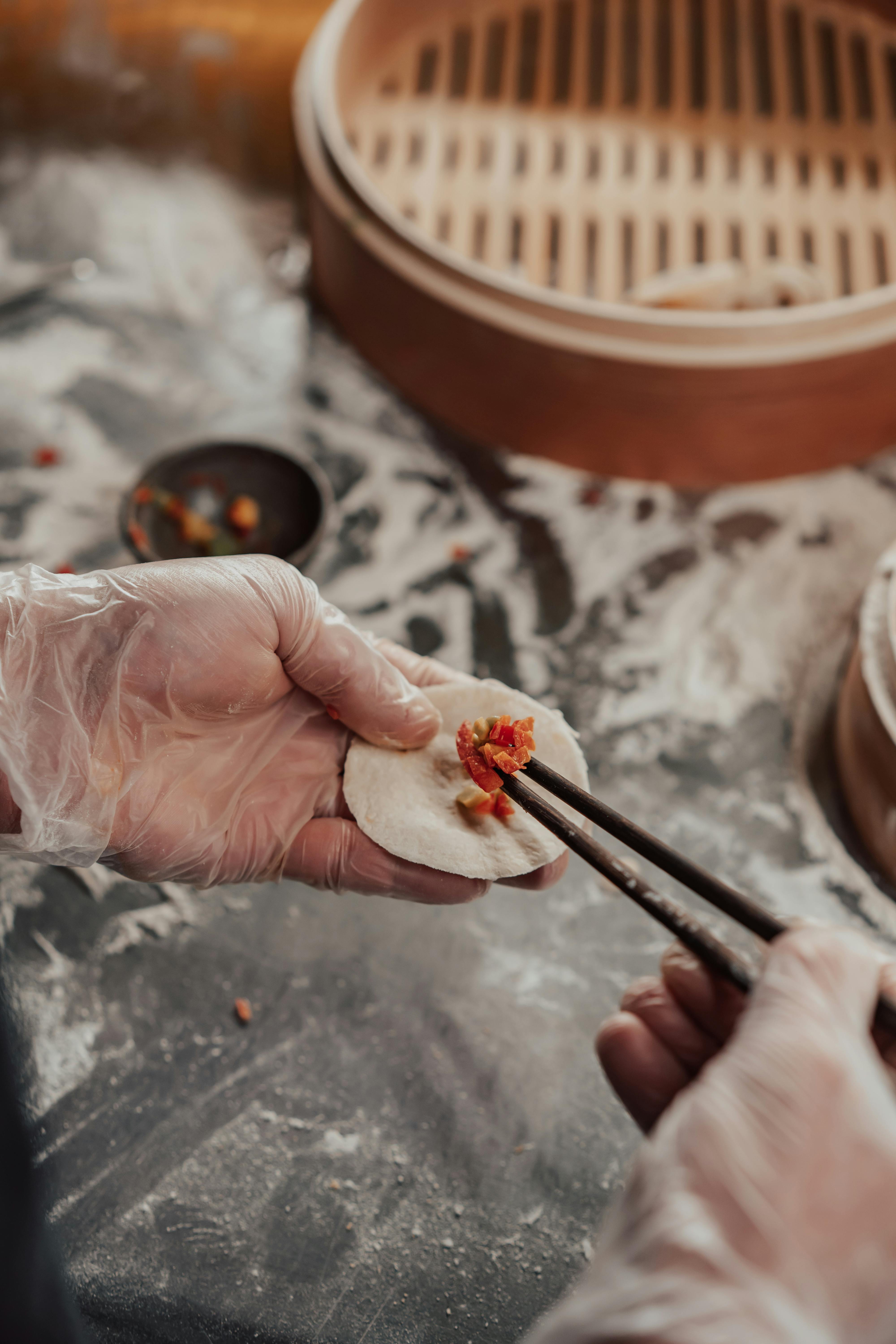 Close-Up Shot of a Person Making a Dumpling · Free Stock Photo