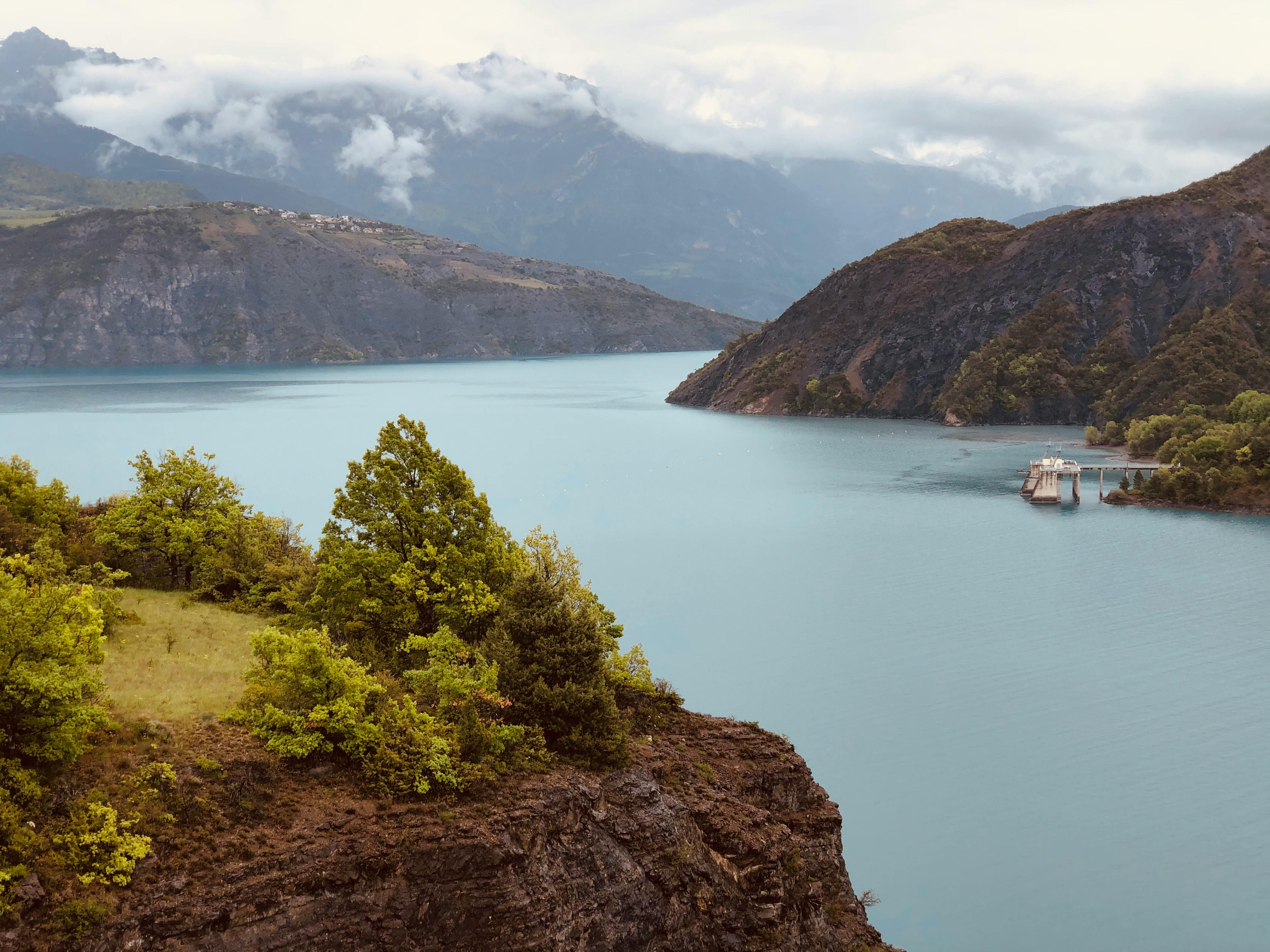 Brown Mountain Near the River · Free Stock Photo