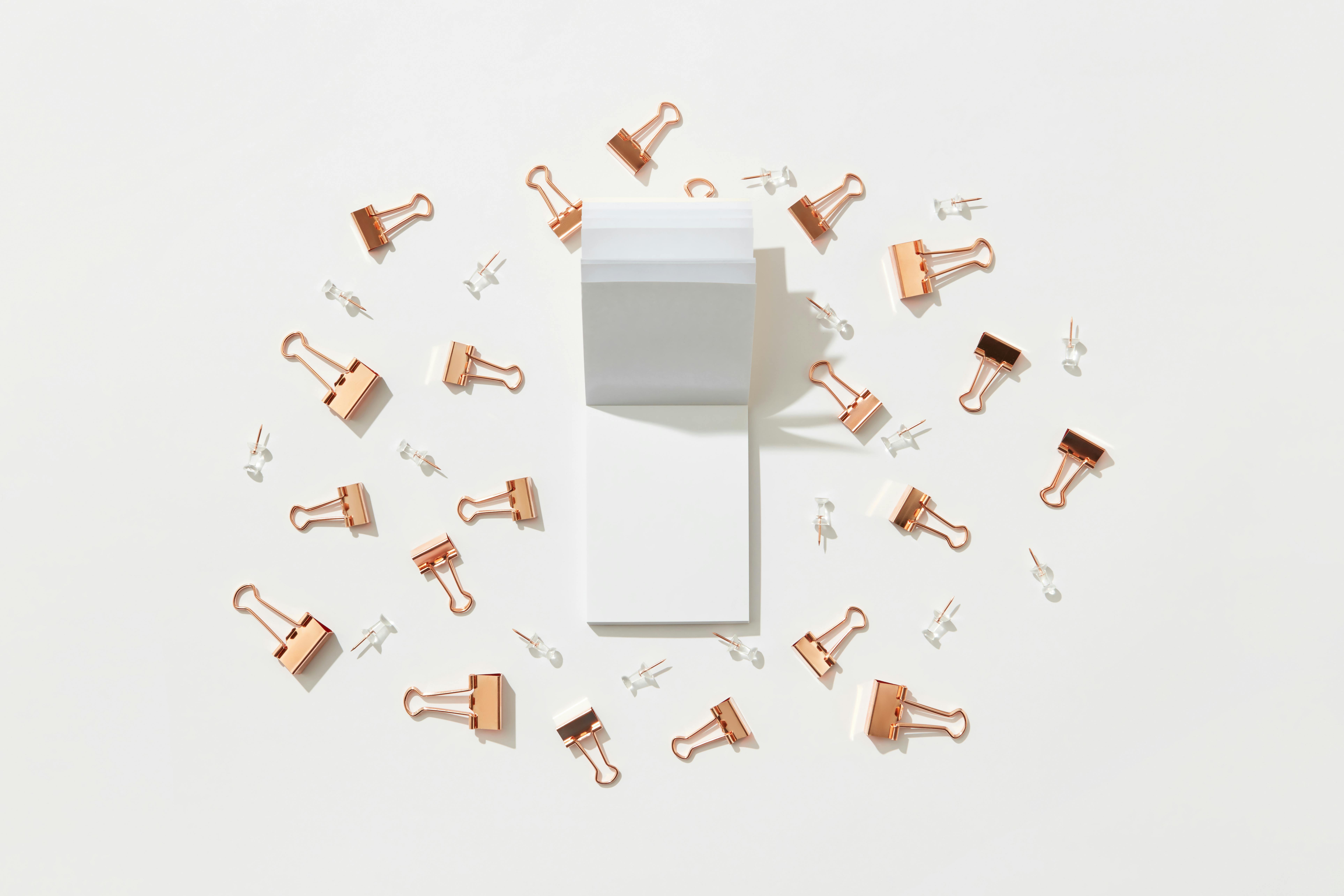Pins and Paper Clips Around Notepad · Free Stock Photo