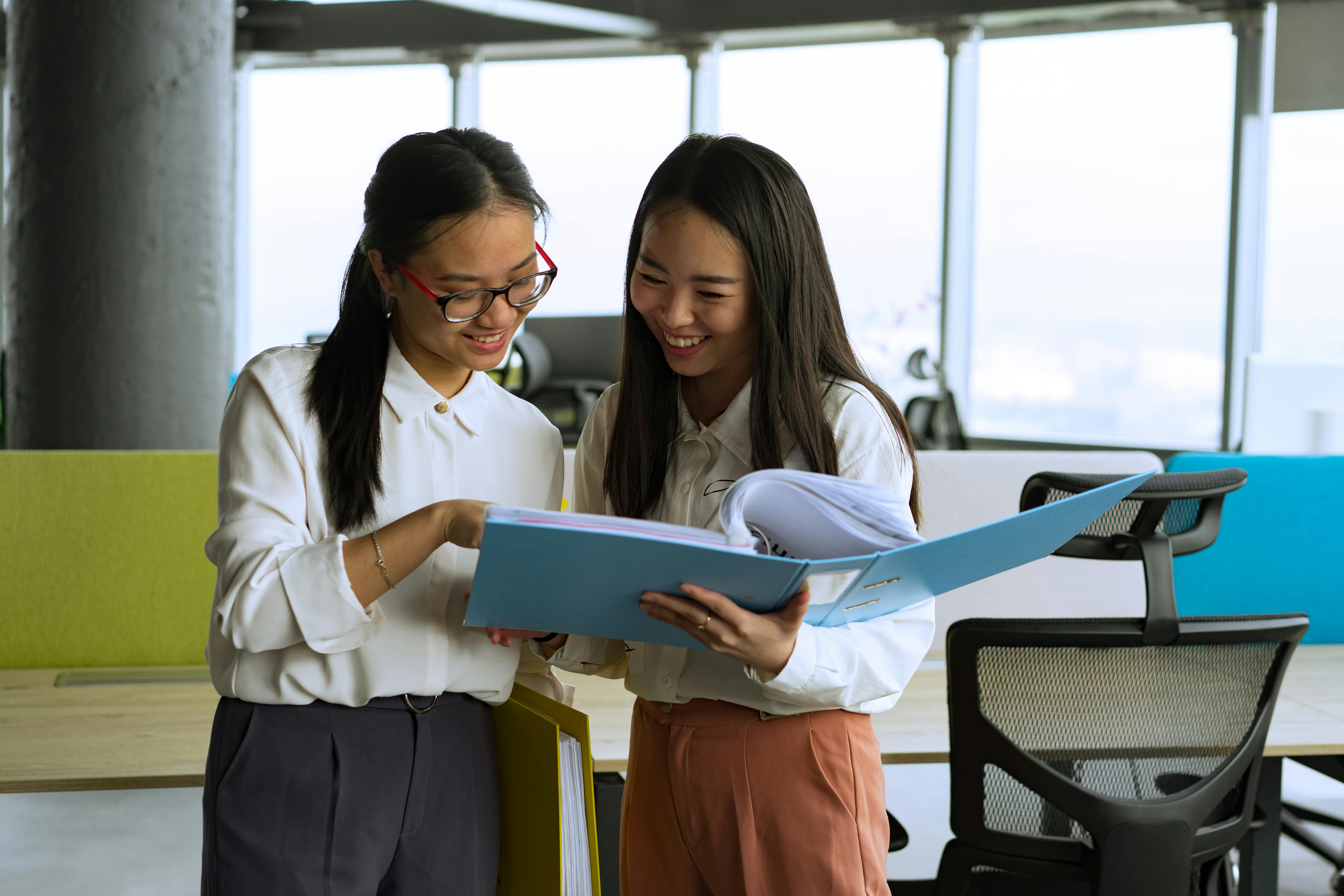 Women Discussing Work in the Office · Free Stock Photo