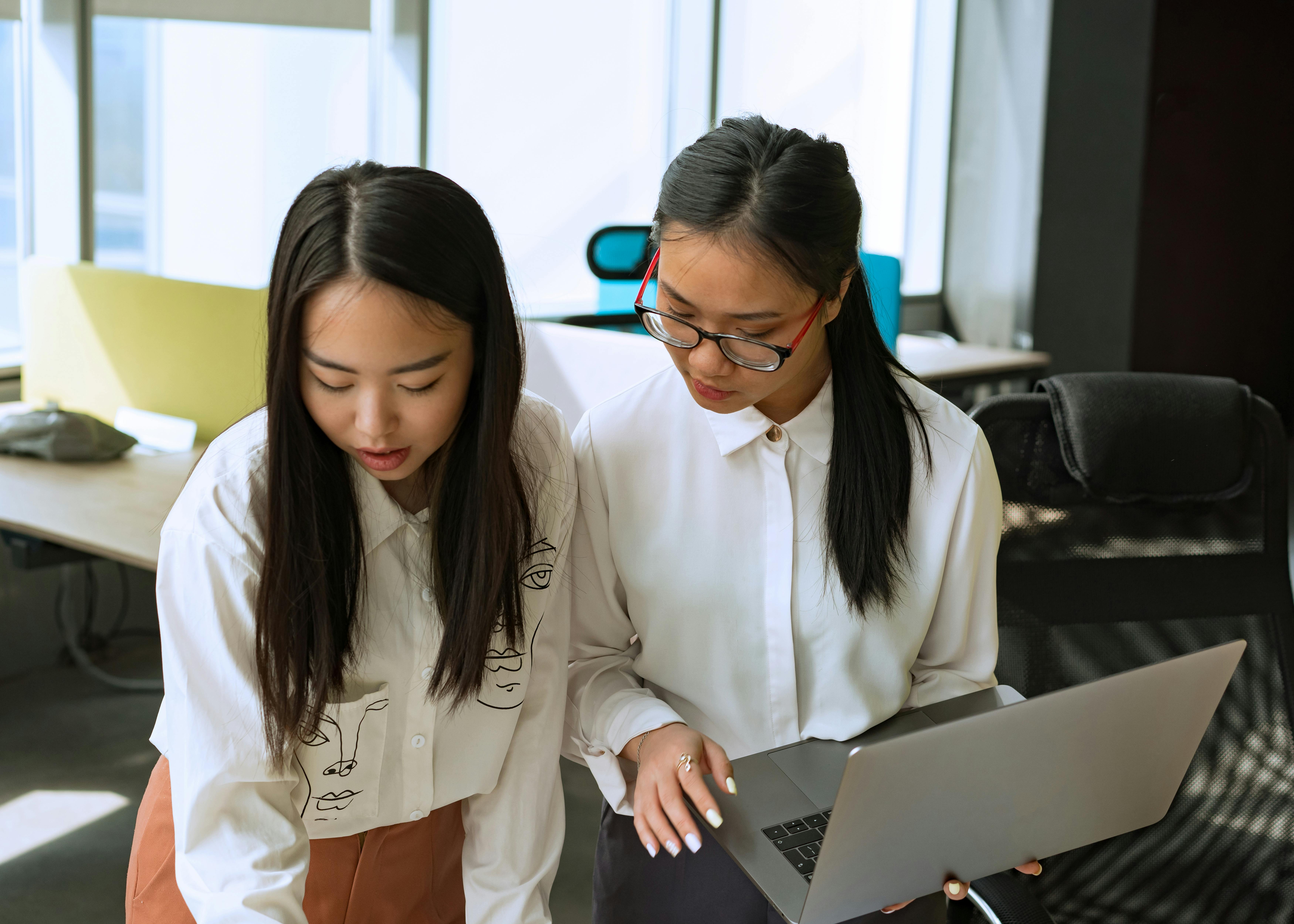Two Women in White Dress Shirt Working Together · Free Stock Photo
