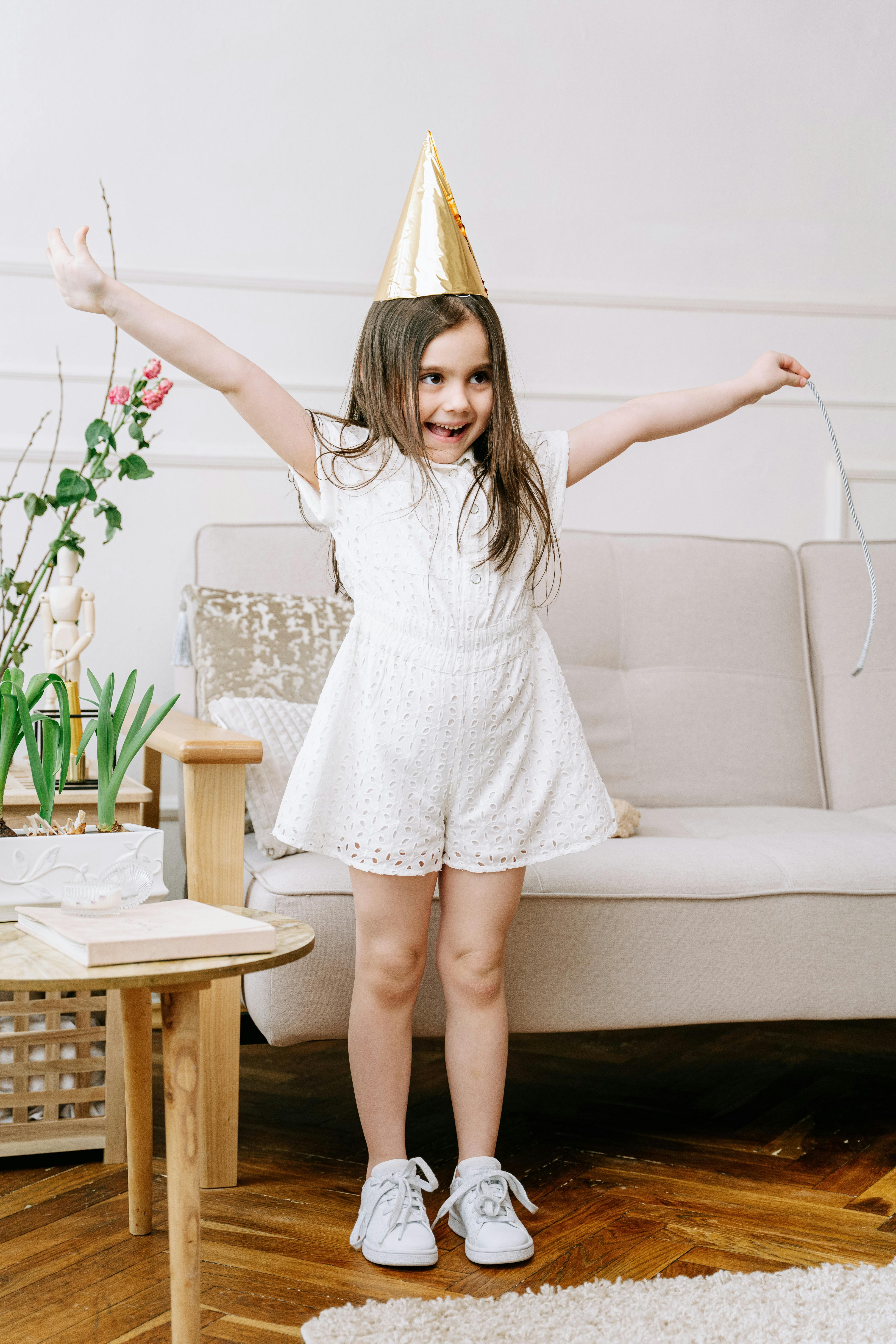 Photograph of a Girl with a Gold Party Hat · Free Stock Photo