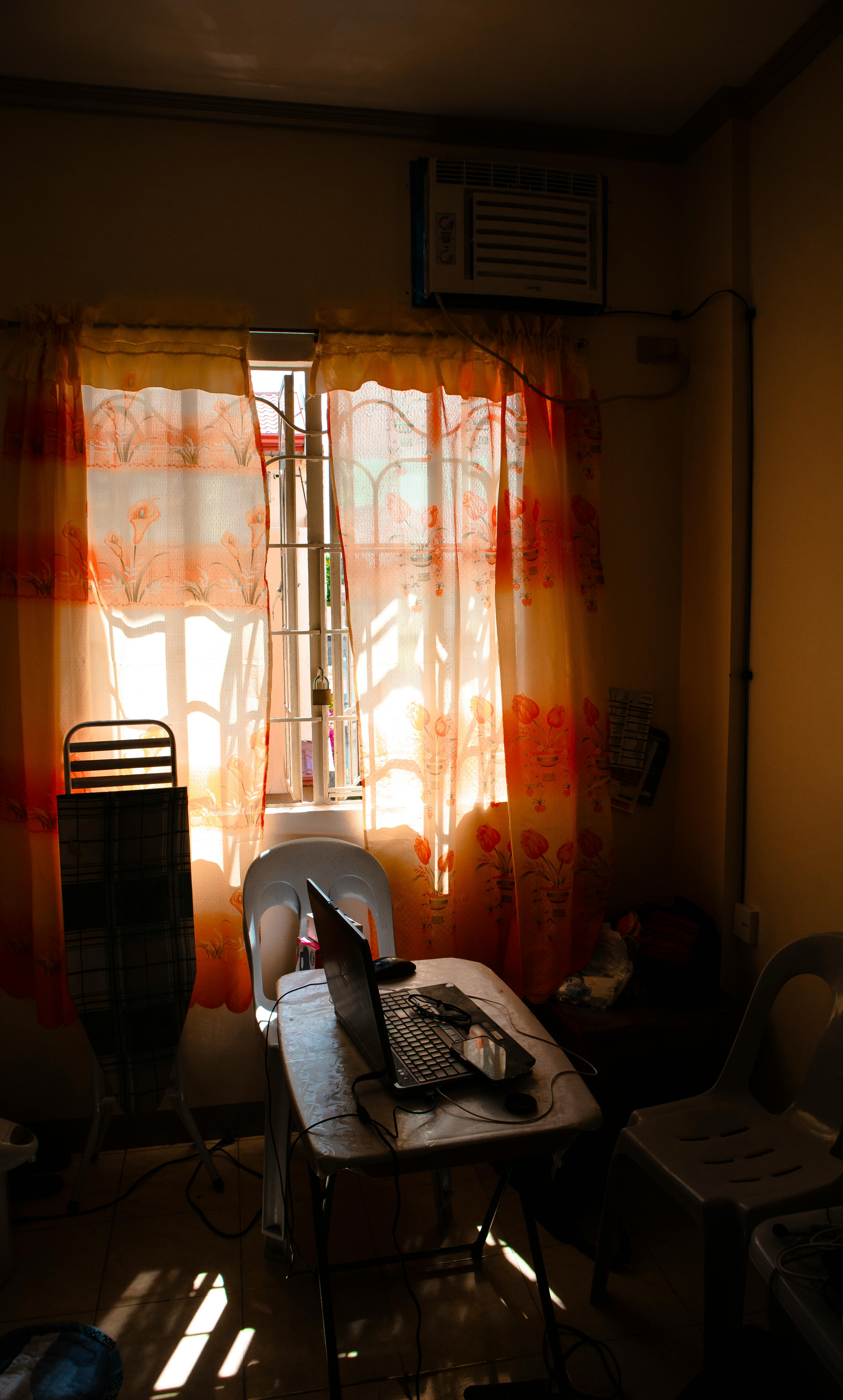 A Laptop On Table Inside A Dark Room · Free Stock Photo