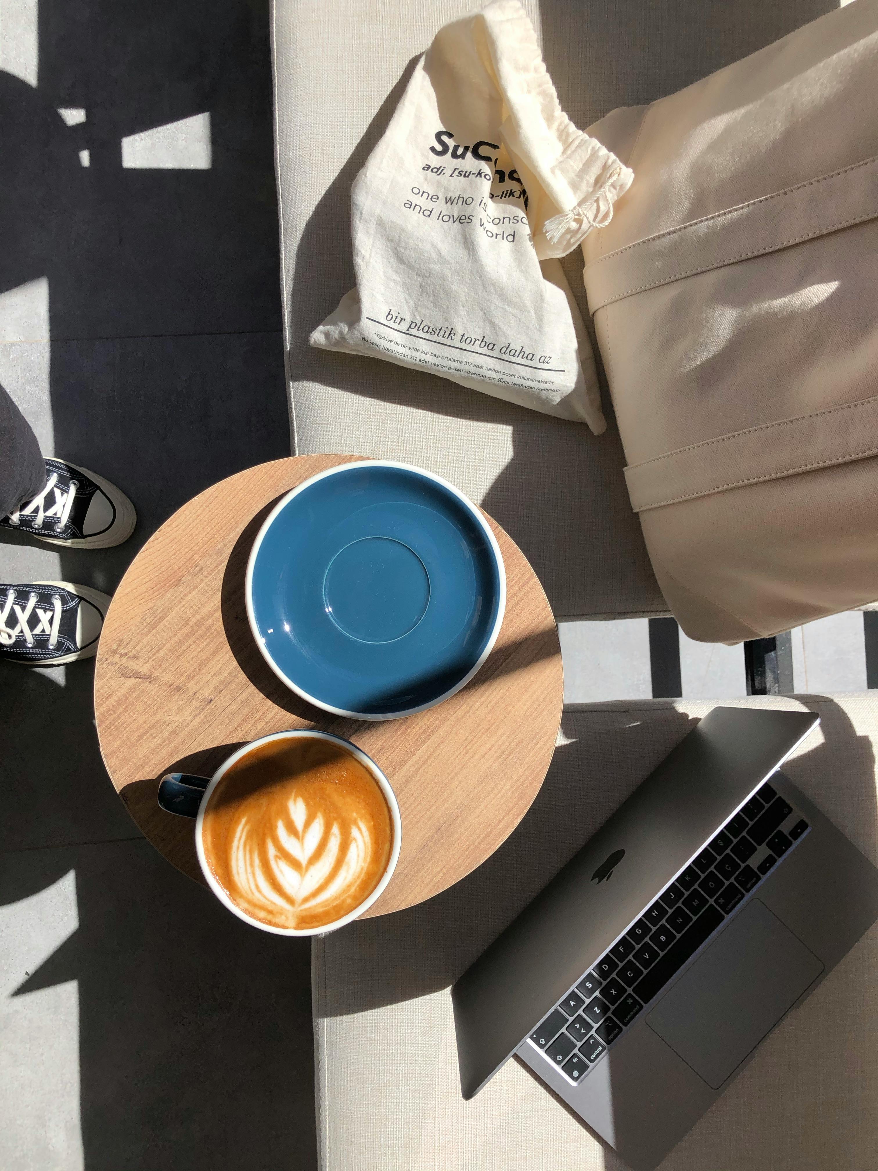 Earring Lying on a Table Next to Coffee · Free Stock Photo