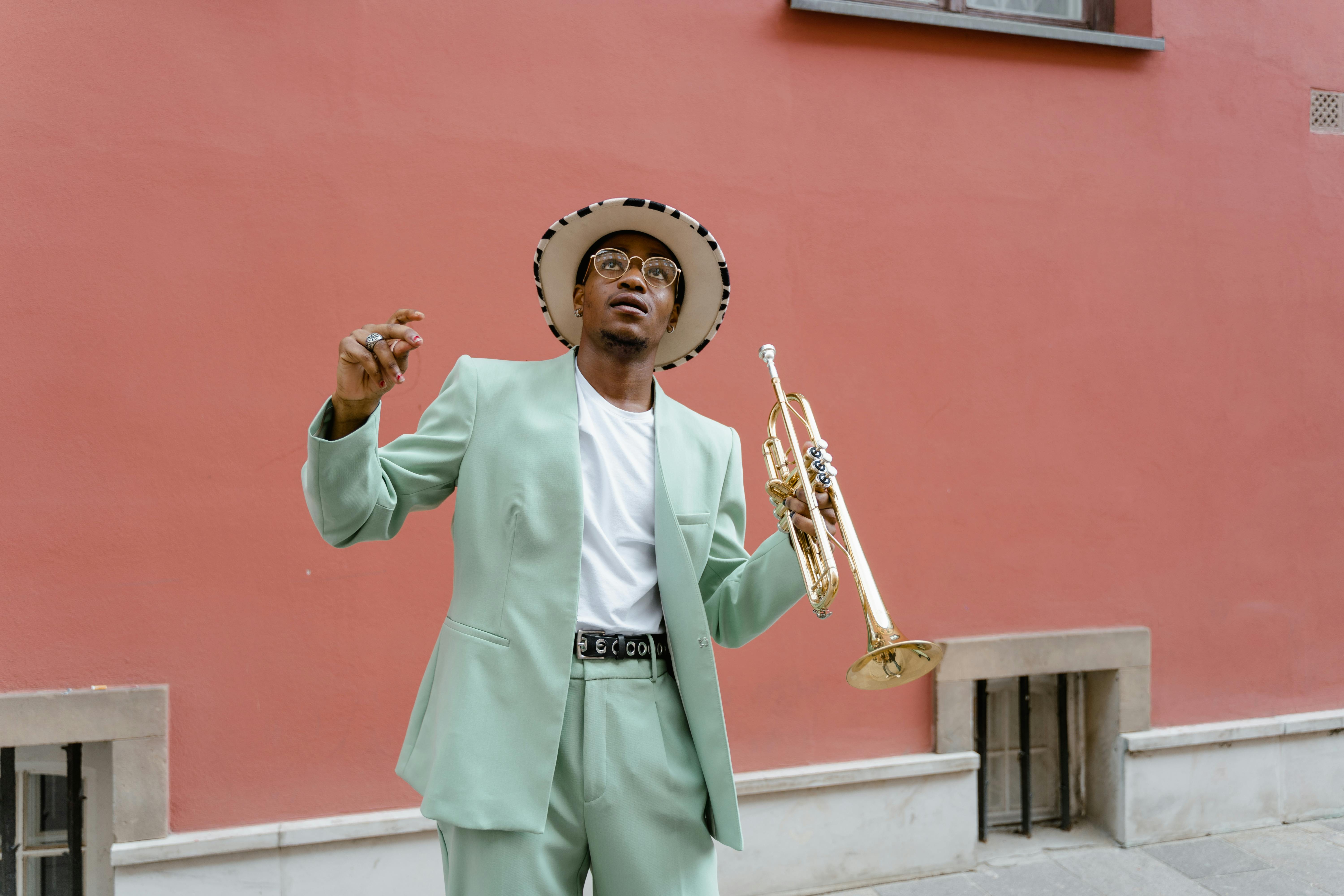 Man Playing Brass Instrument during Daytime · Free Stock Photo
