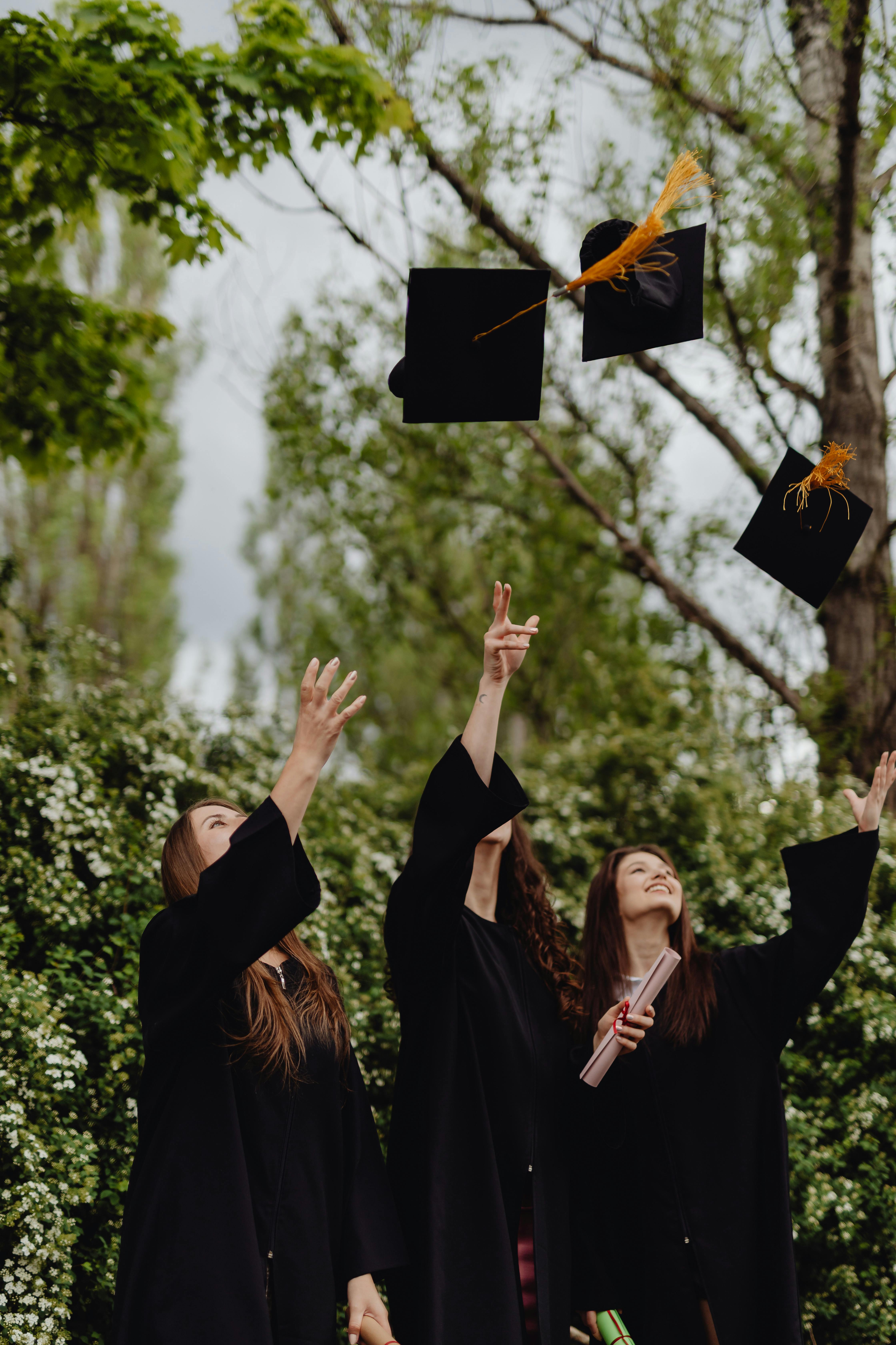 Women Throwing their Graduation Hats · Free Stock Photo