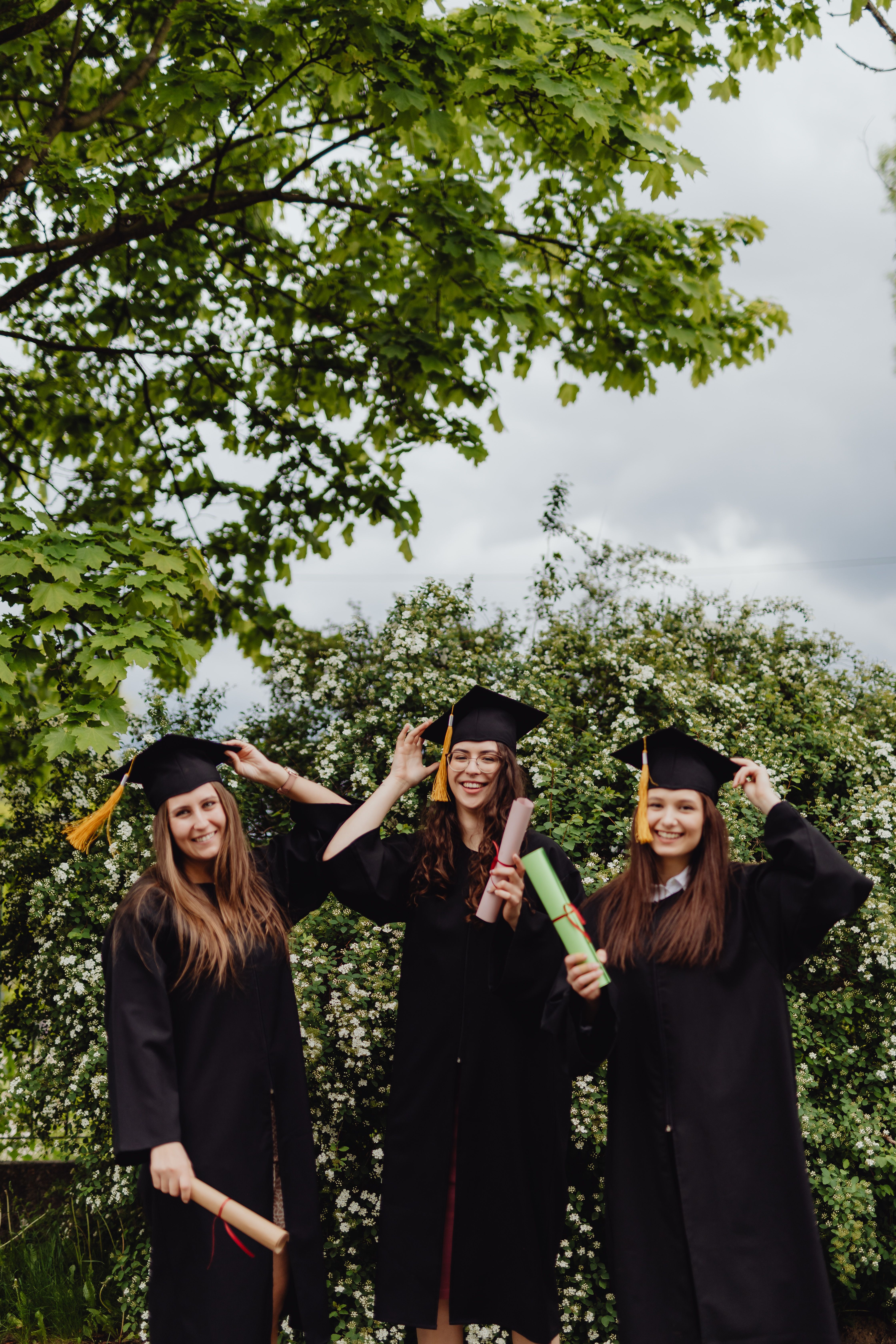 Women Wearing Graduation Gowns Holding their Graduation Hats · Free ...