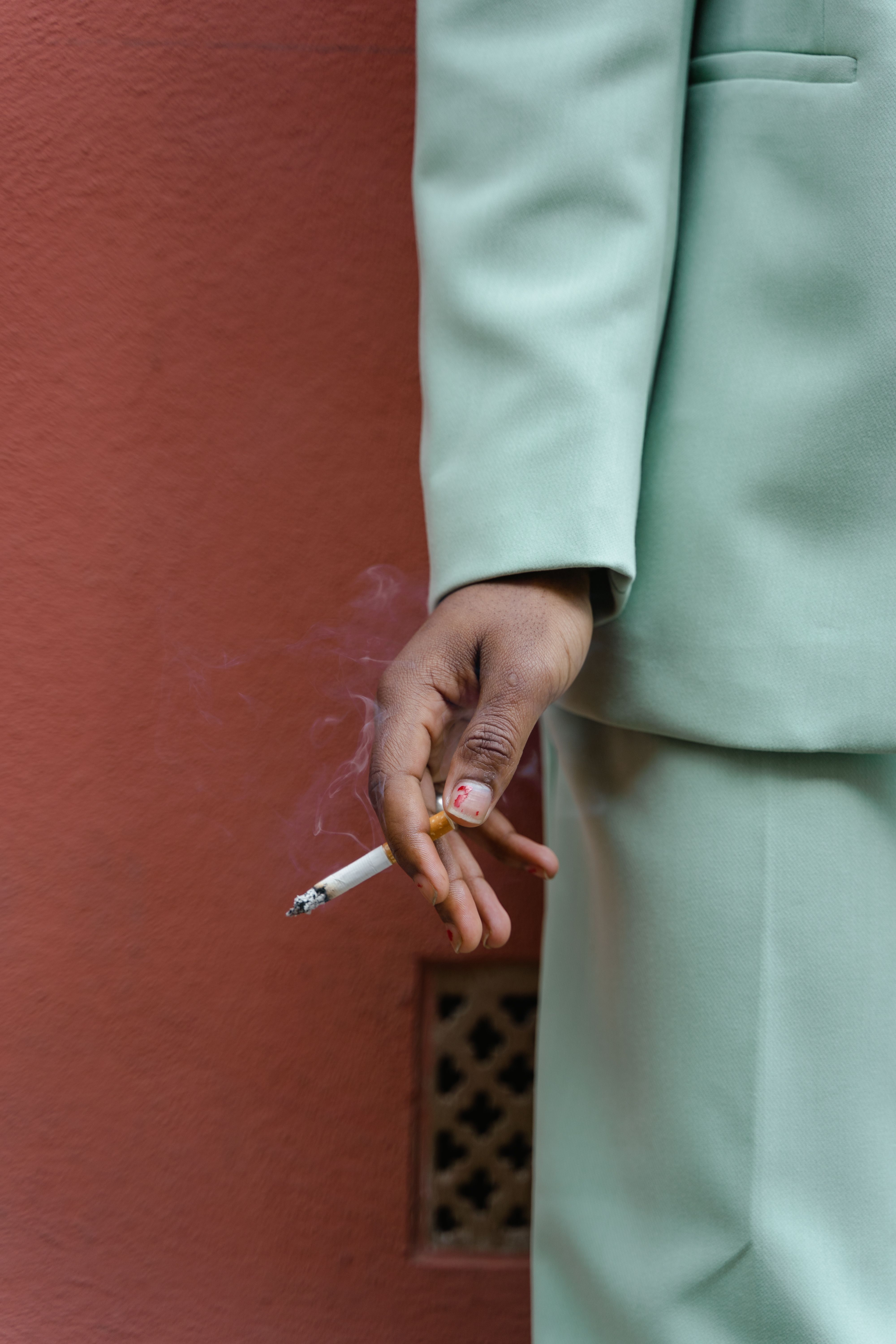 Man Leaning on the Wall Smoking · Free Stock Photo
