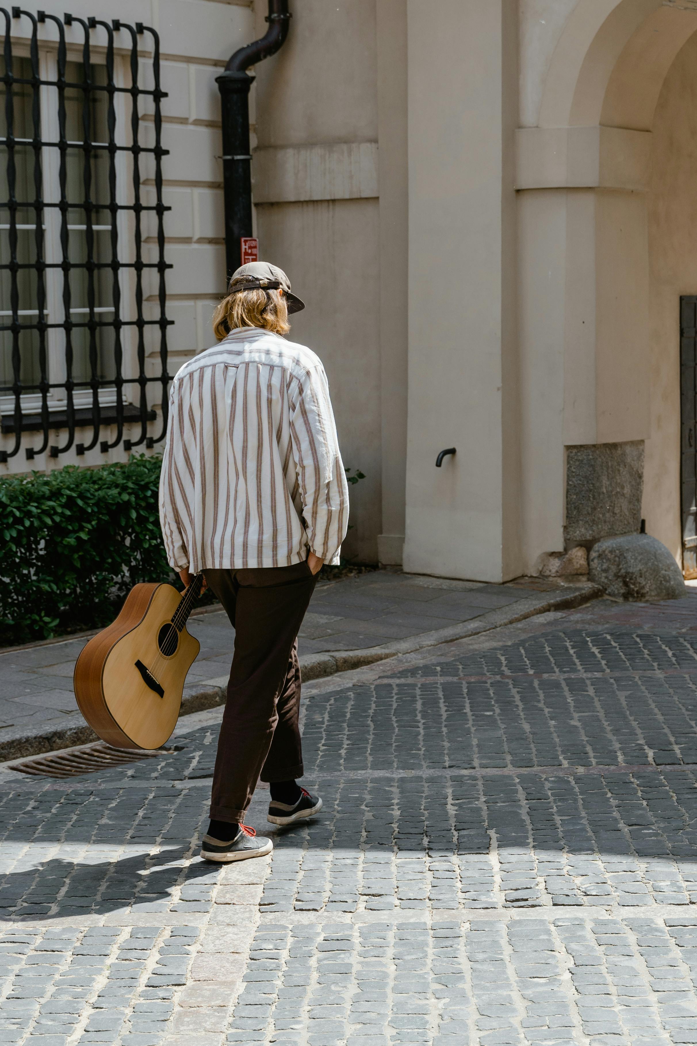 Man Walking Carrying His Guitar · Free Stock Photo