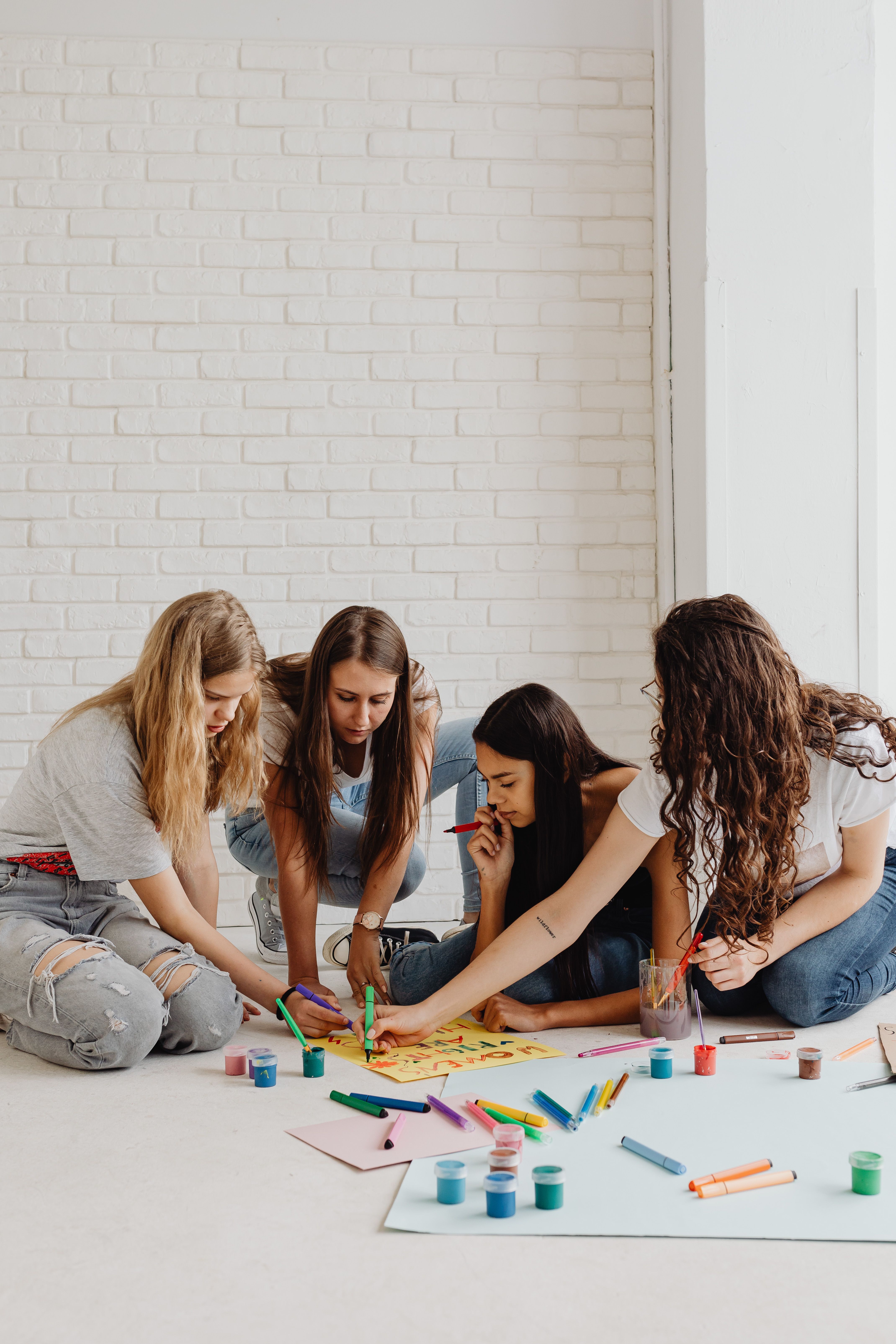 Group of Women Sitting on Floor Making a Poster · Free Stock Photo